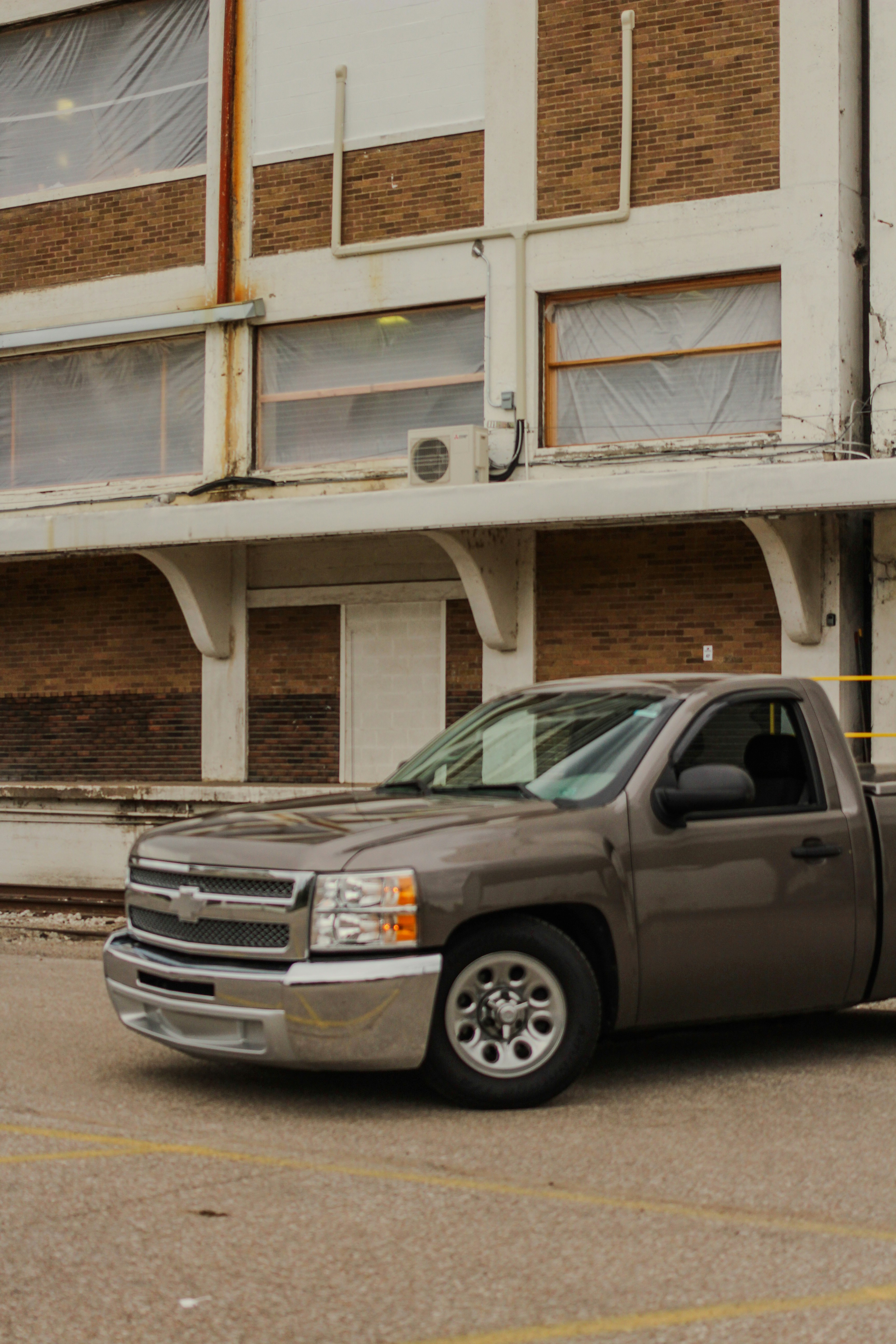 Truck in the Parking Lot Before an Aged Brick Building