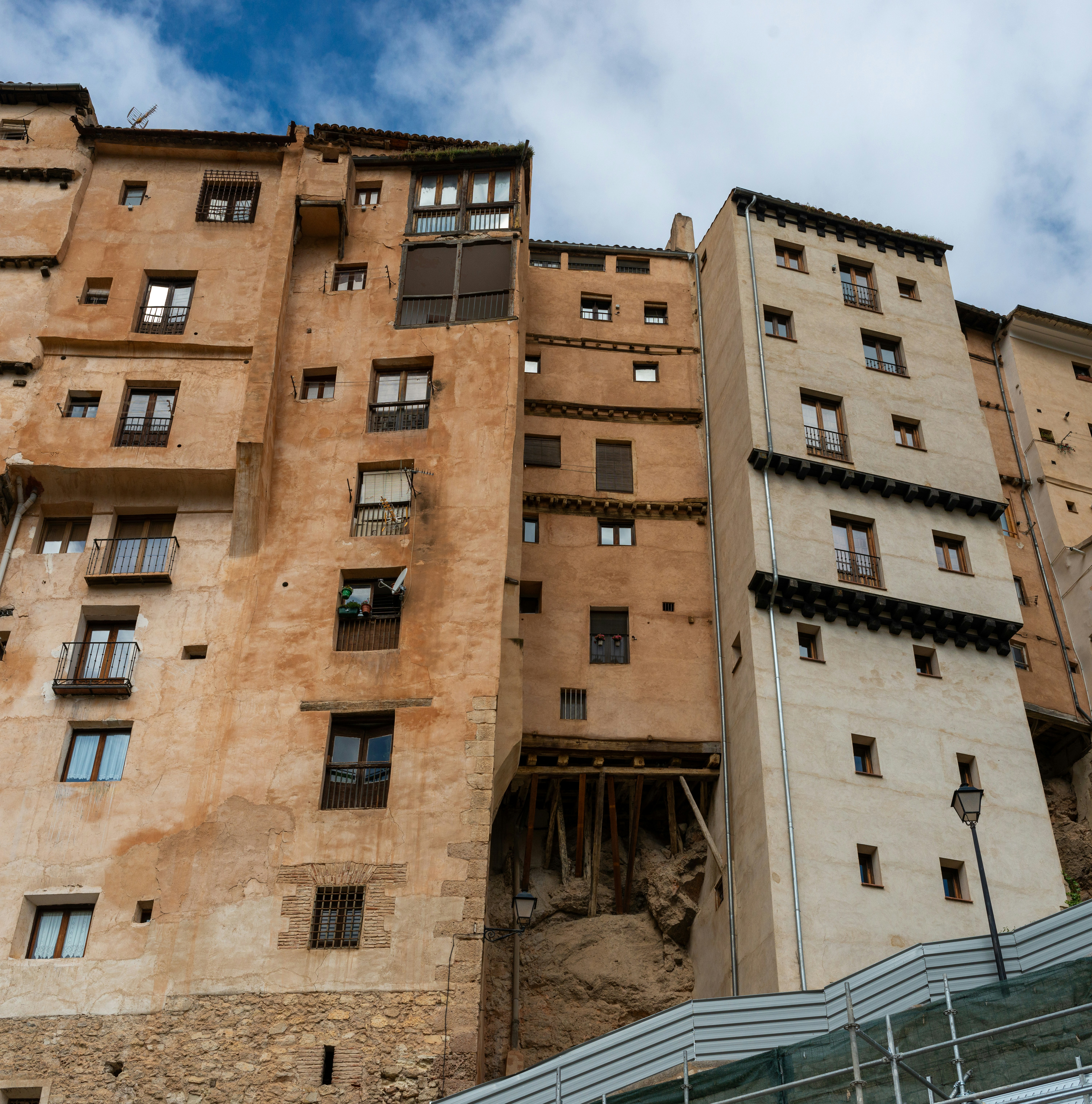 Cliffside Flats: Weathered Facades Clinging to a Rocky Verge