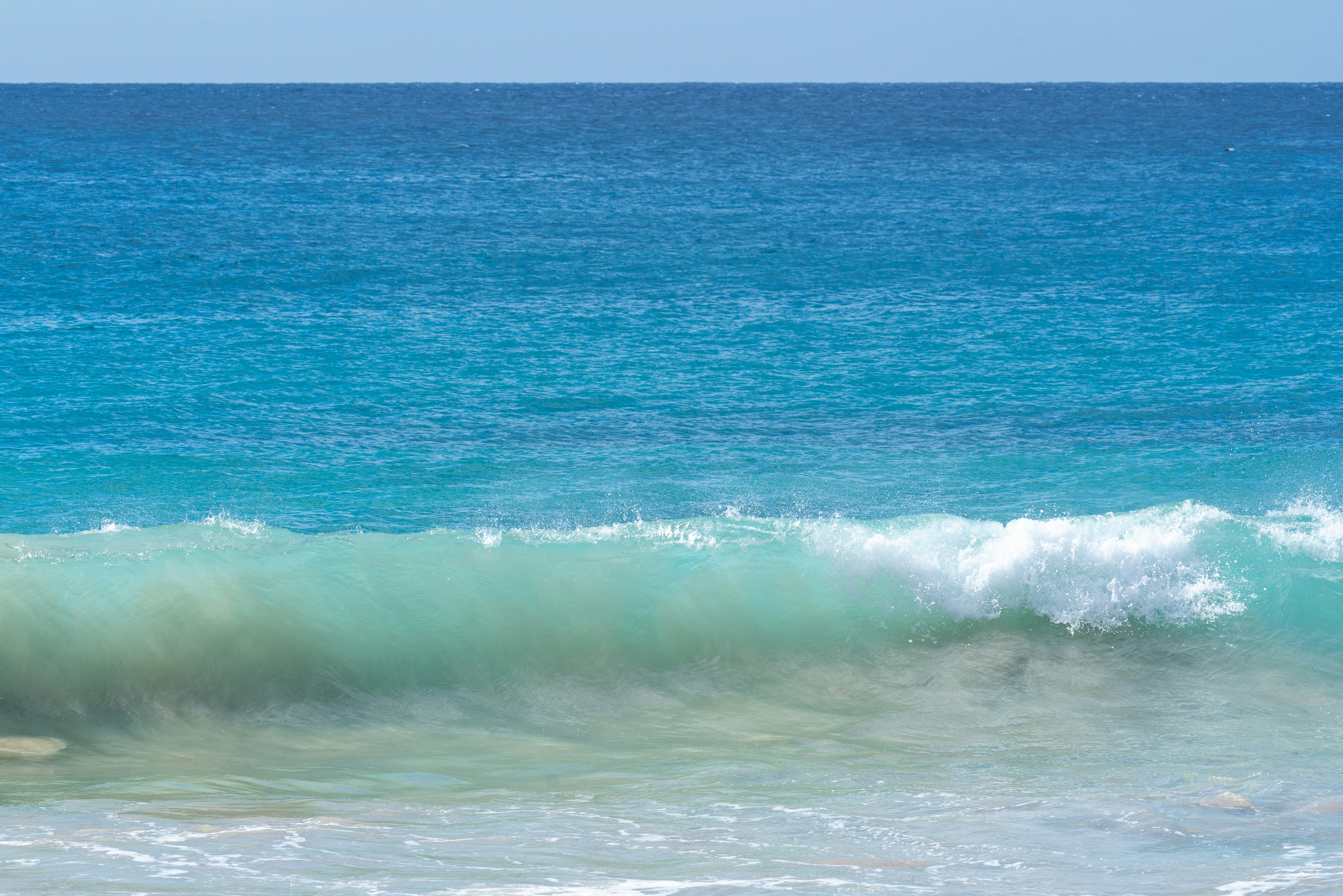 A man riding a wave on top of a surfboard photo – Free Blue Image on ...