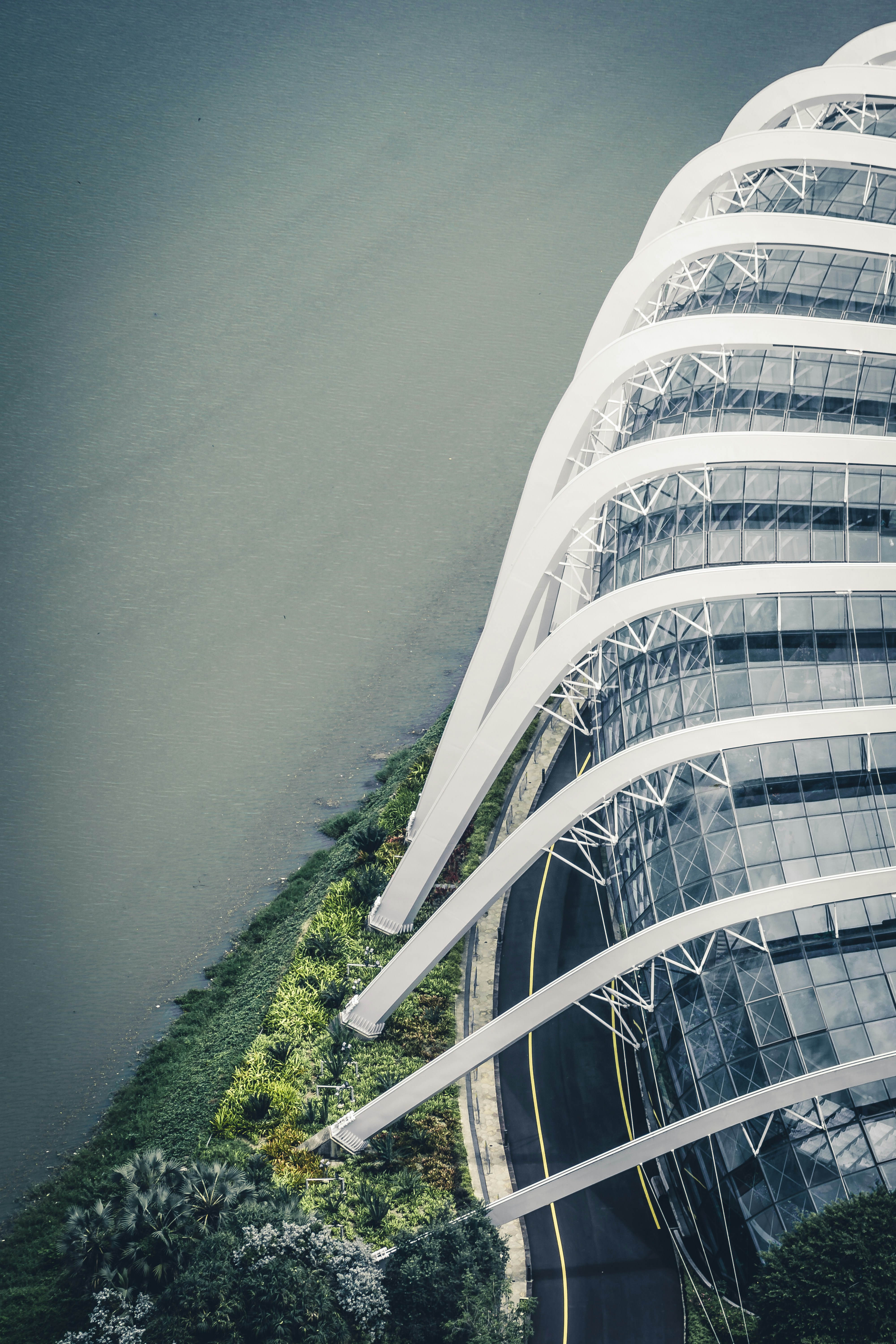 an aerial view of a building next to a body of water