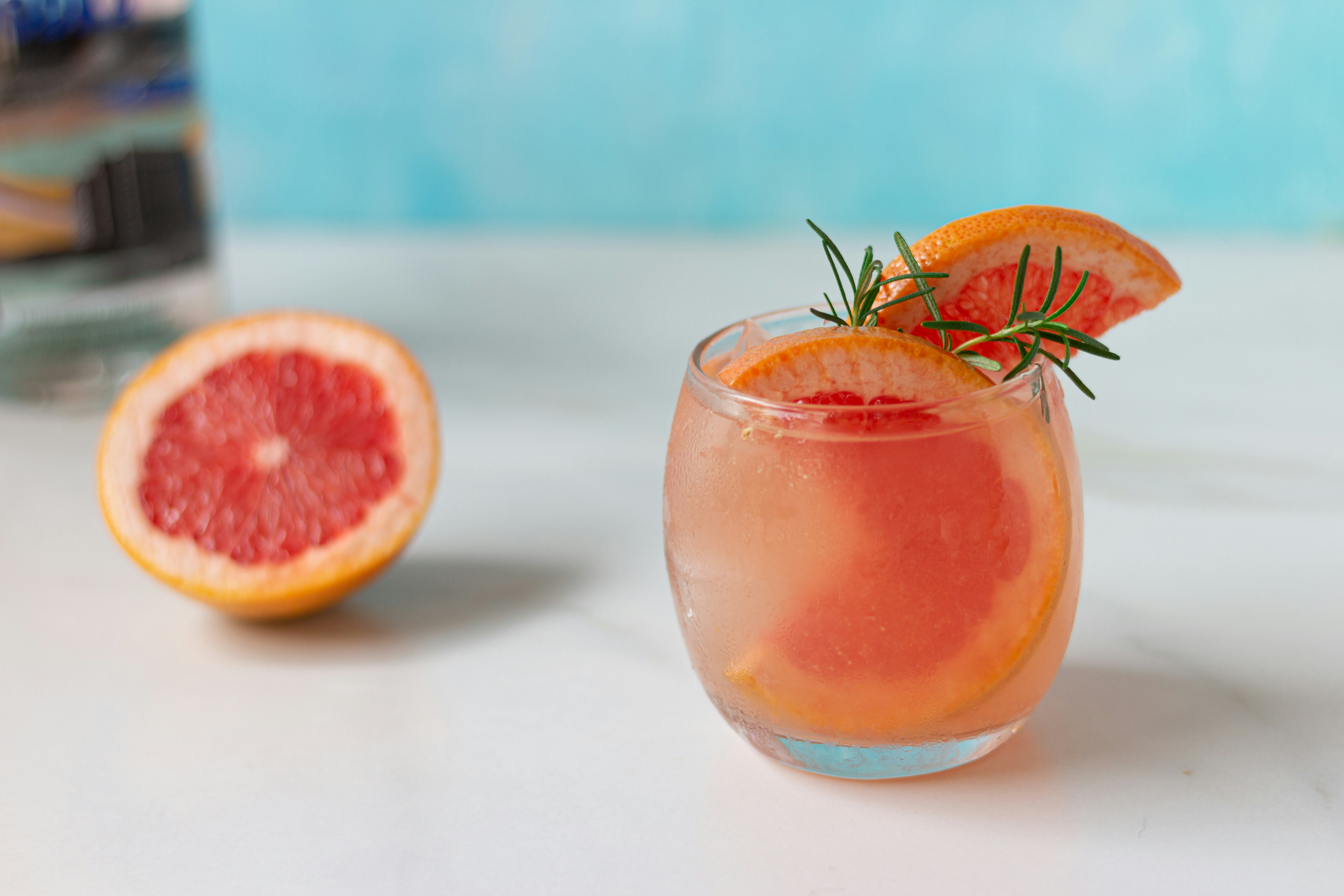 A grapefruit cocktail garnished with a rosemary garnish photo – Free ...