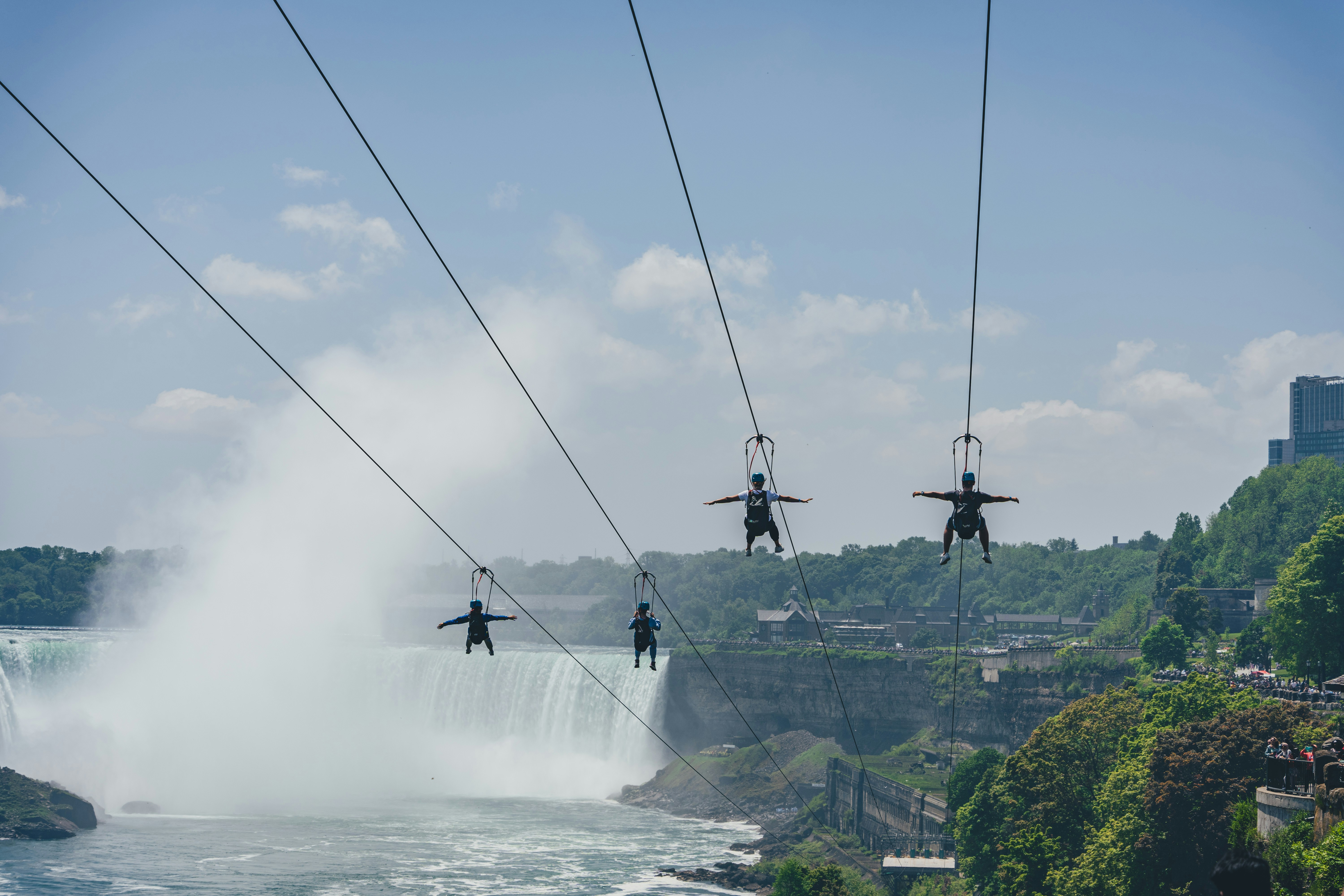 A group of people on a rope above a waterfall photo – Free Waterfall ...