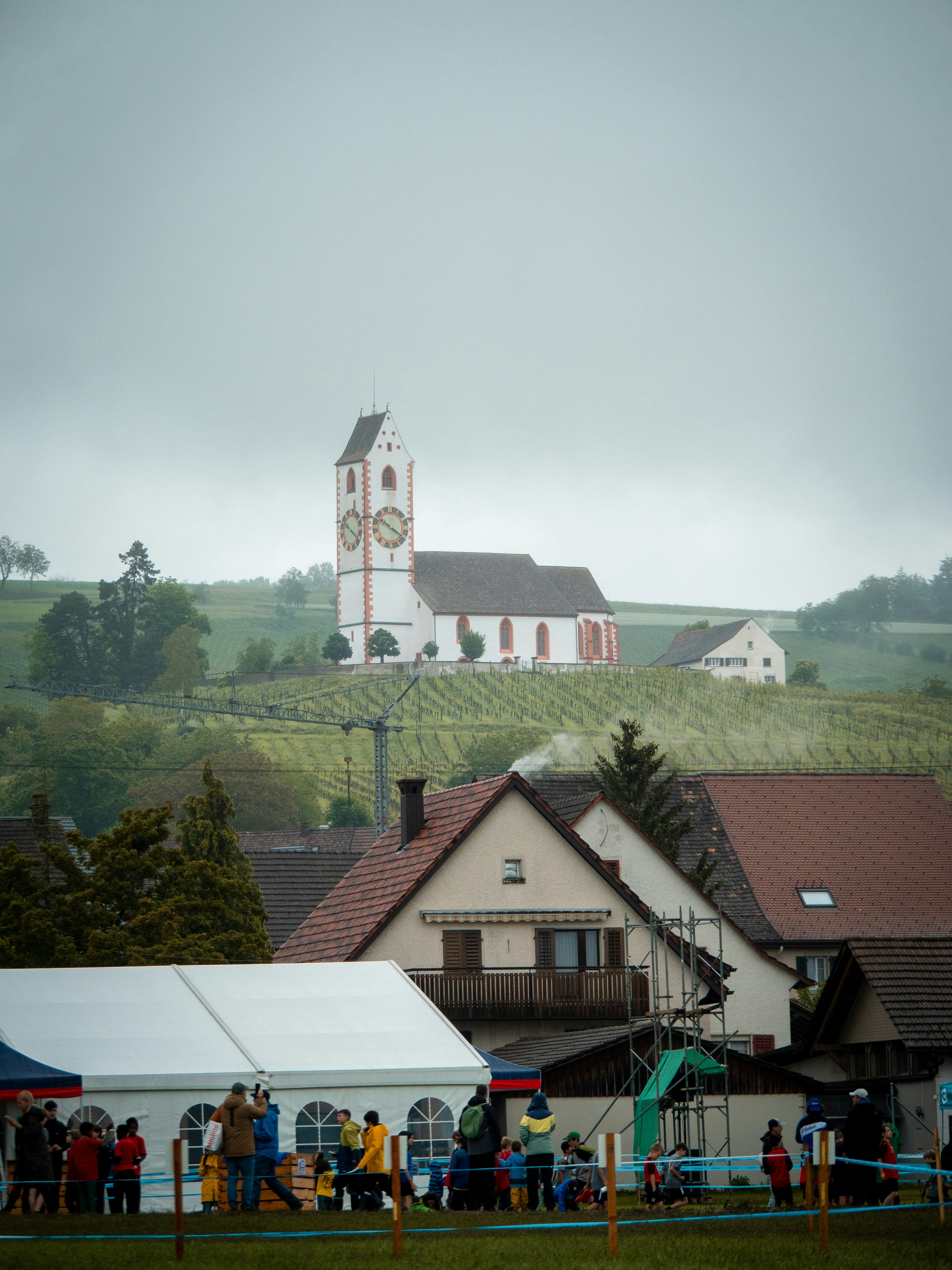 Clock Tower on the Hill: A Village Scene Under Soft Mist