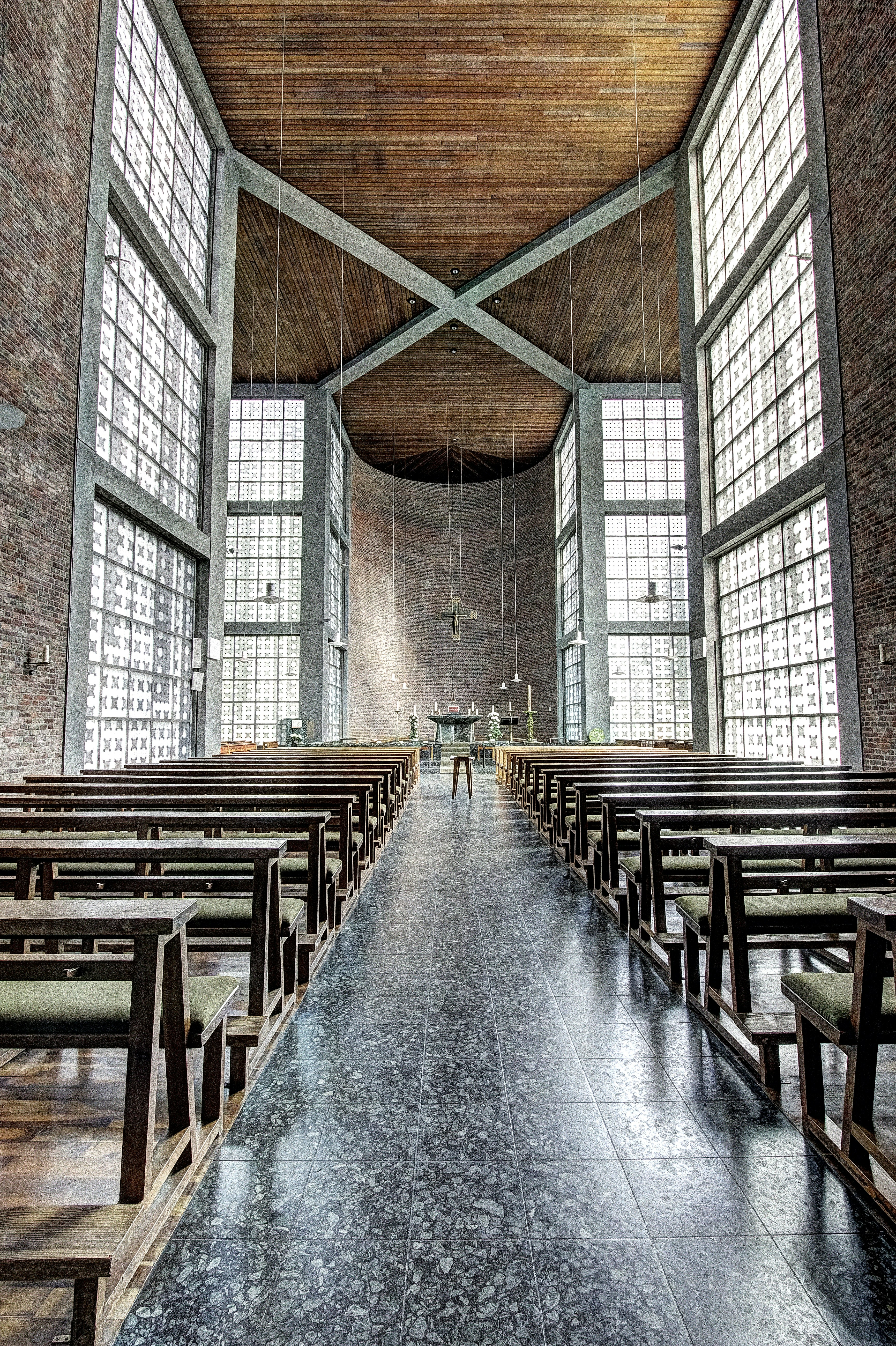 Aisle of Light: Longitudinal View to the Quiet Altar in a Brick Chapel