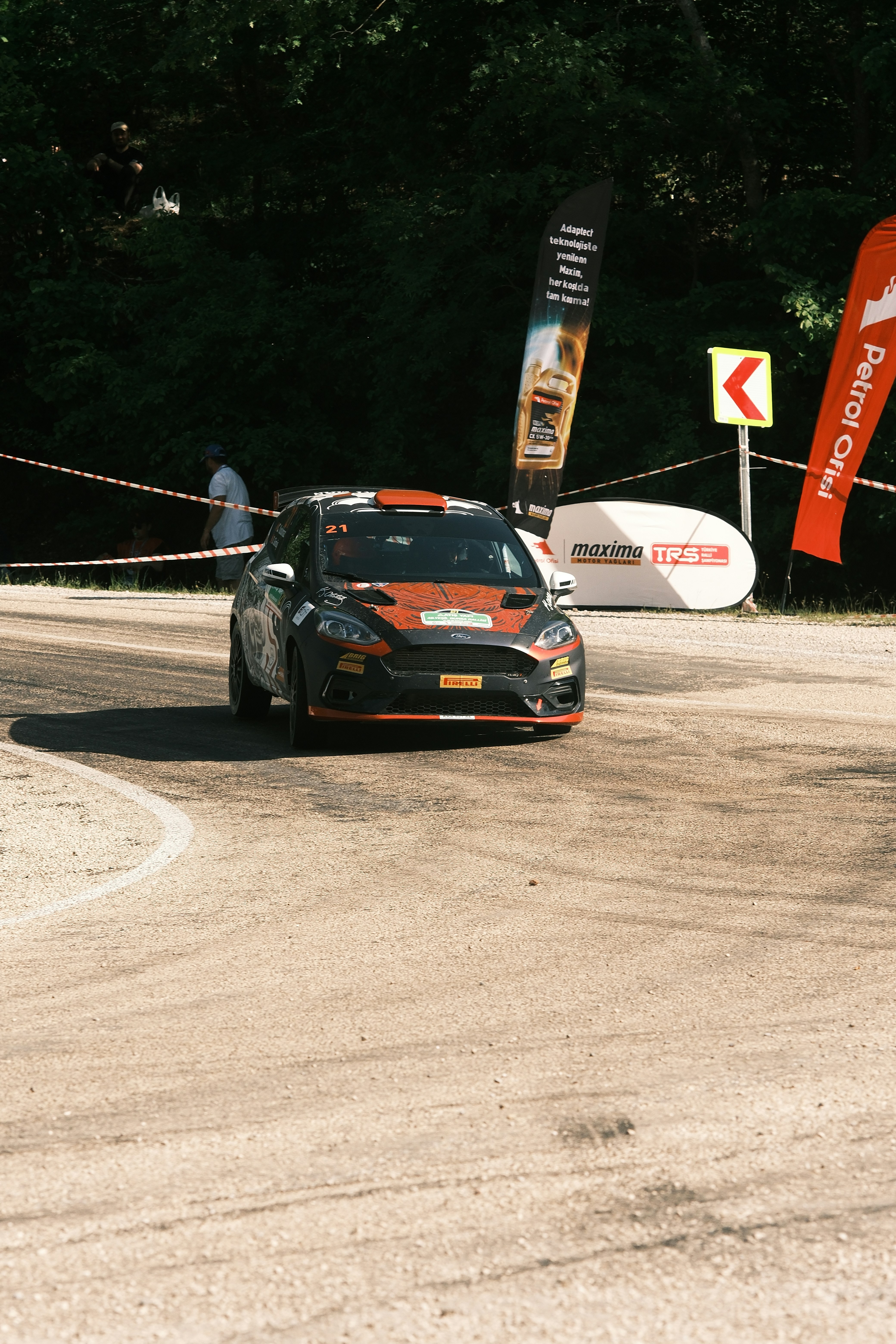 Dust on the Curve: An Orange Rally Car Conquers a Dusty Hairpin