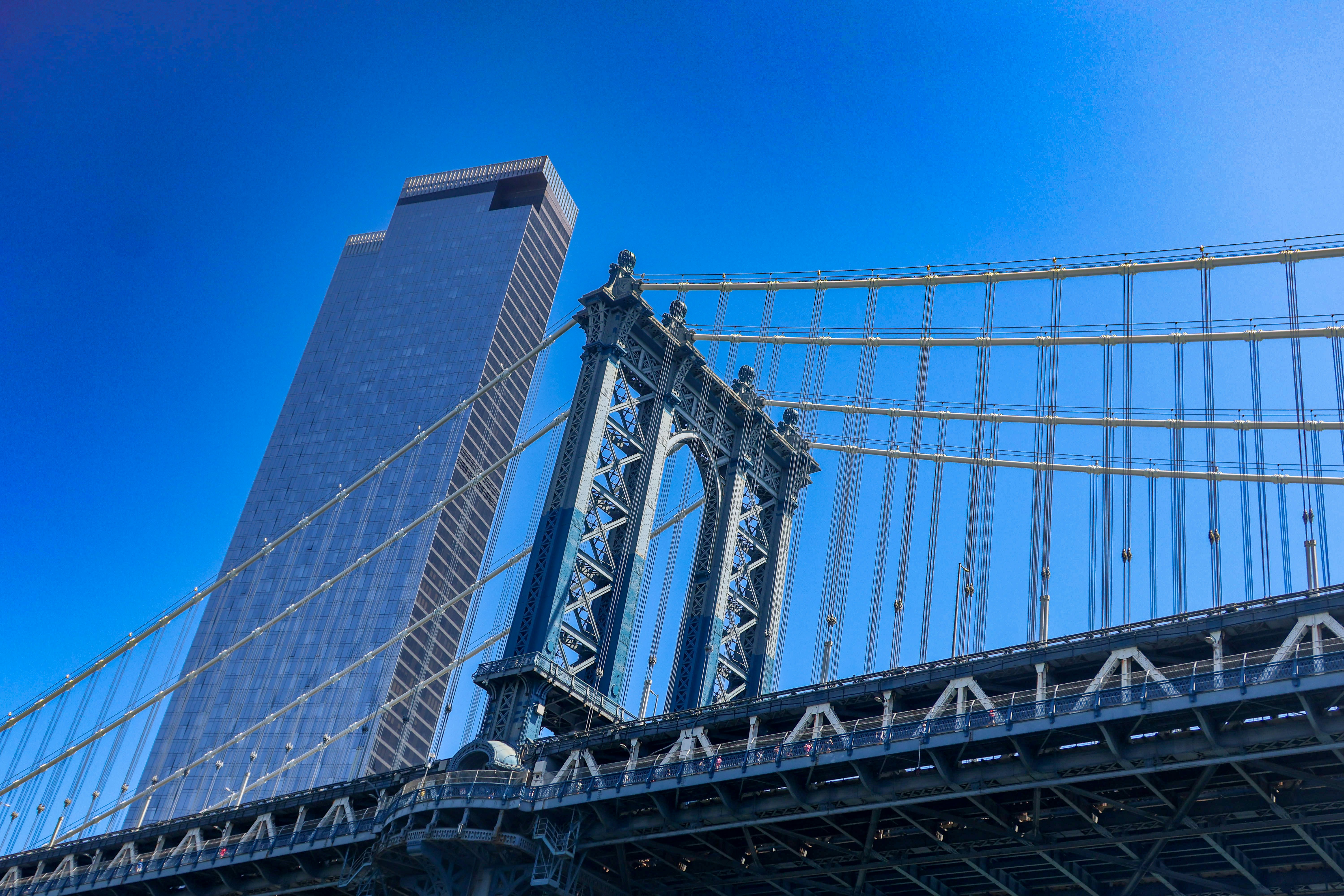 A very tall bridge with a very tall building in the background photo ...