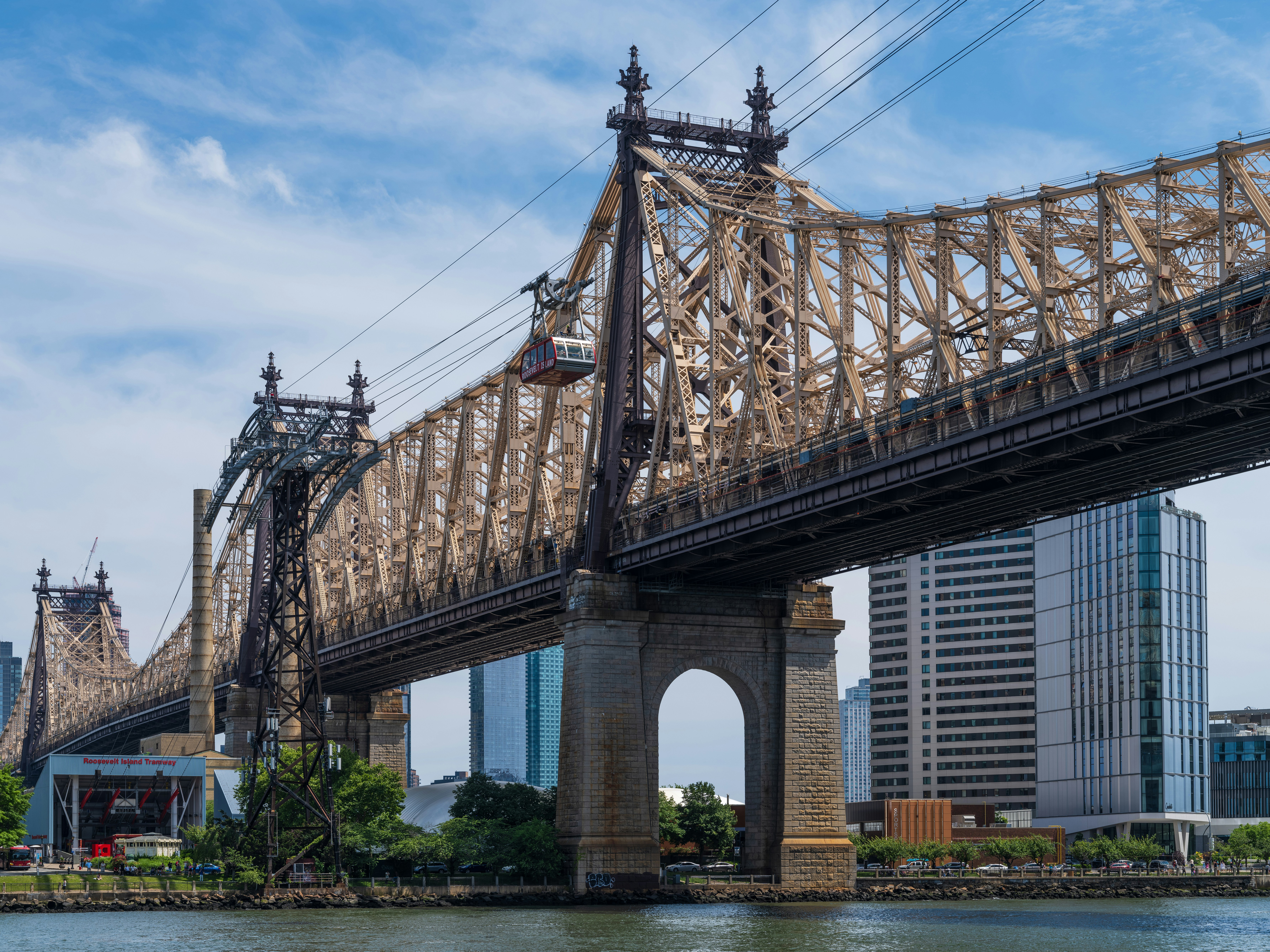 A large bridge spanning over a river next to tall buildings photo ...