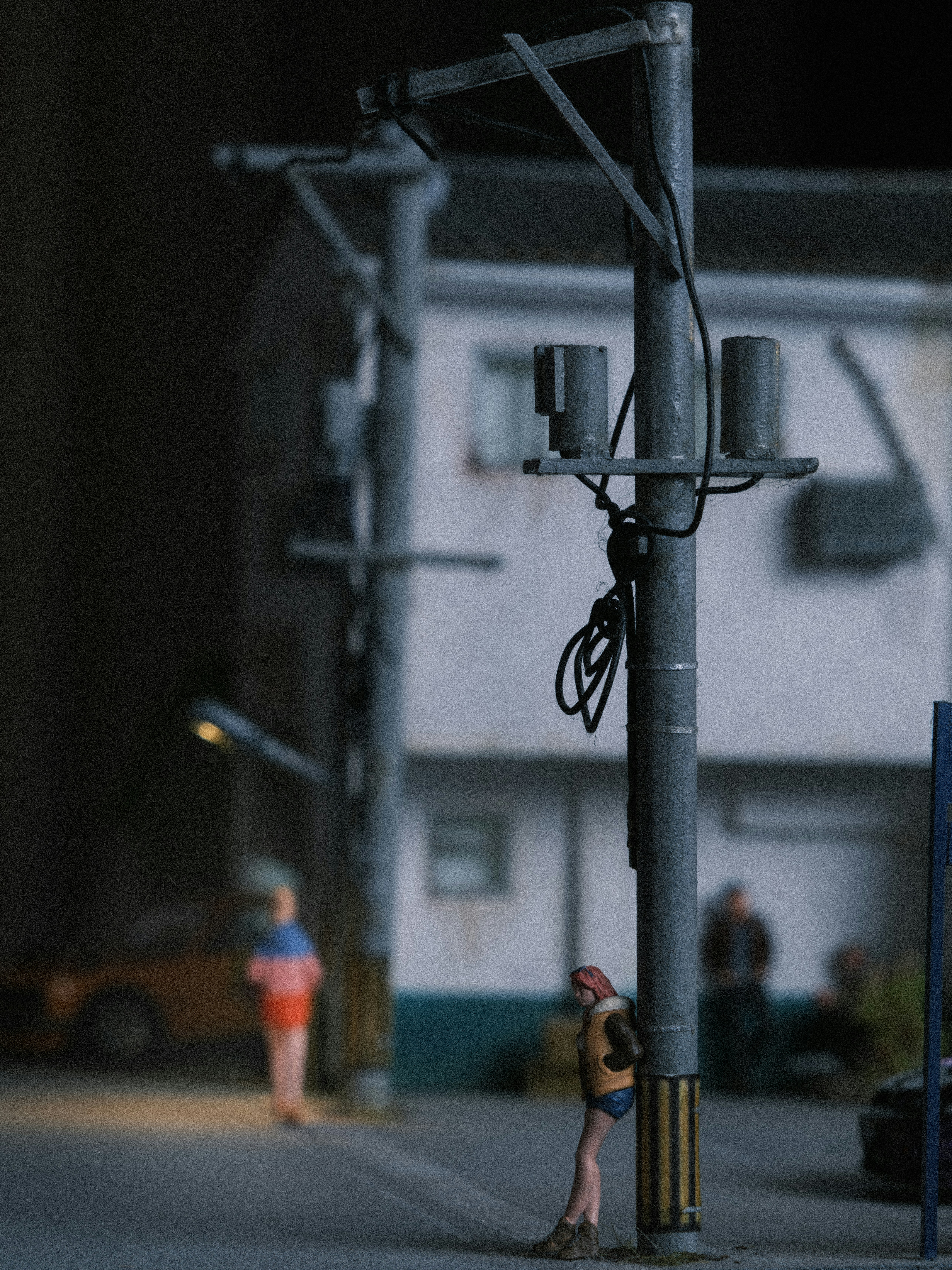 a person standing under a street light next to a building