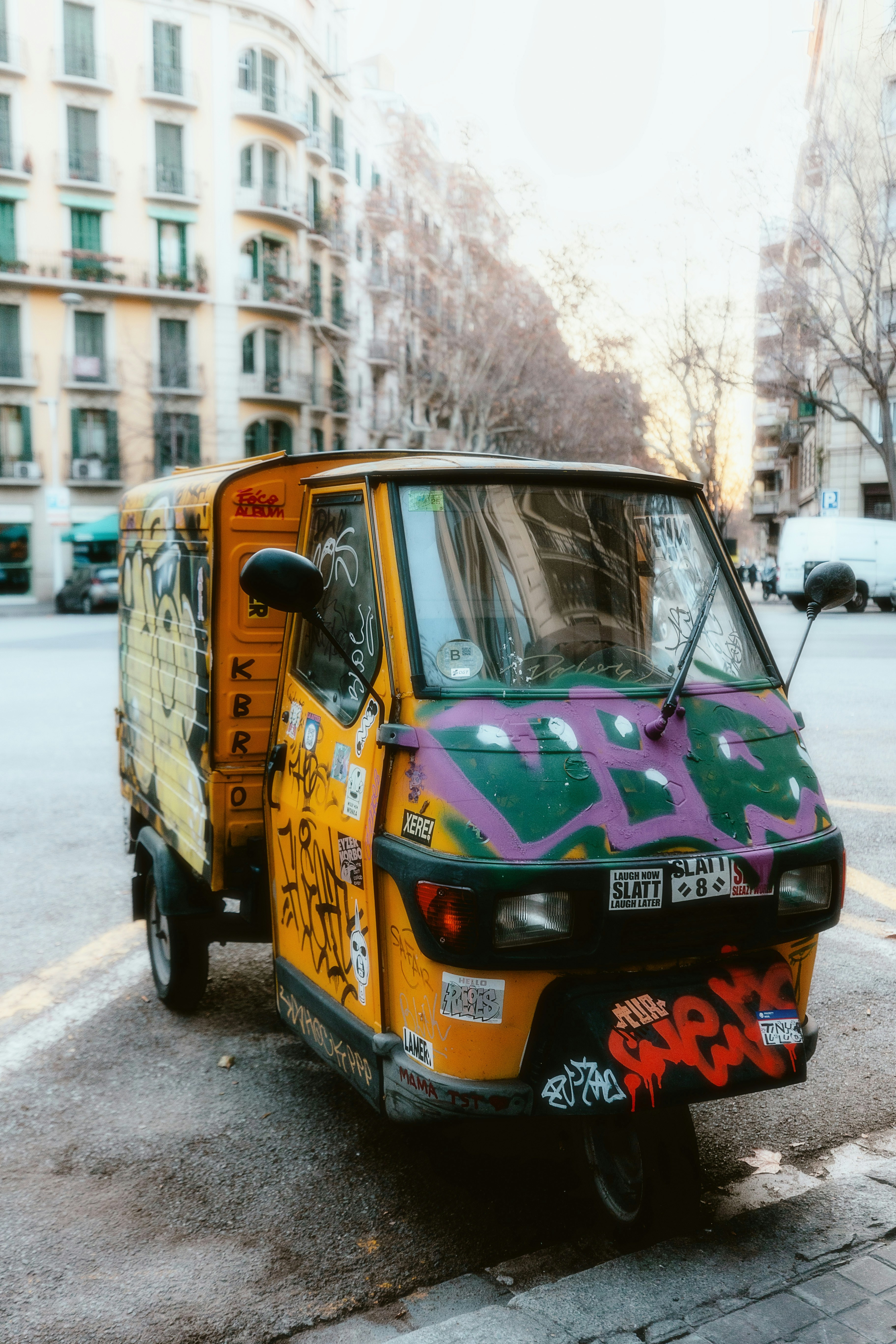 Graffiti-Wrapped Delivery Van Anchors a Quiet City Street