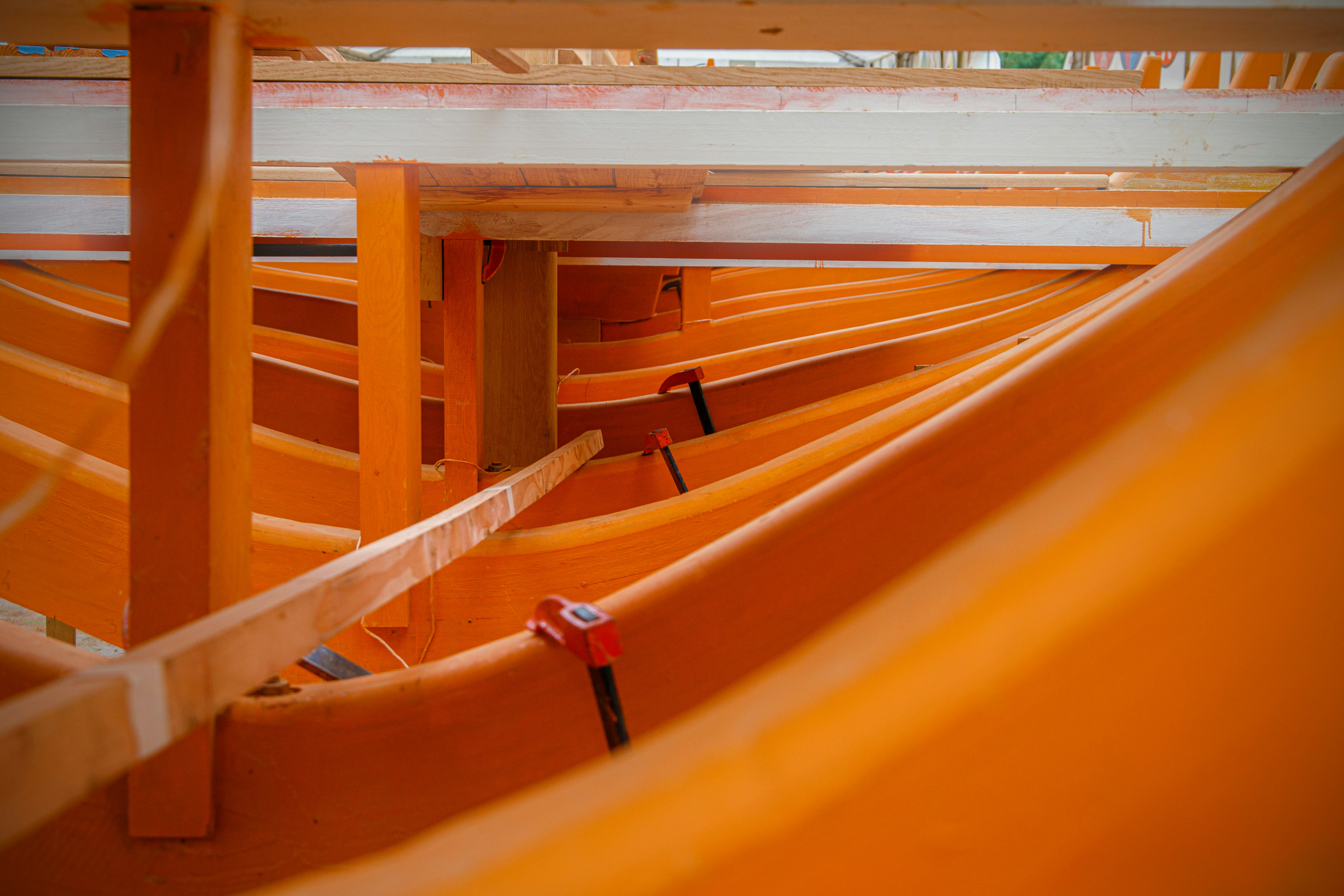 Inside the Orange Vessel: A Geometric Corridor of Wooden Ribs