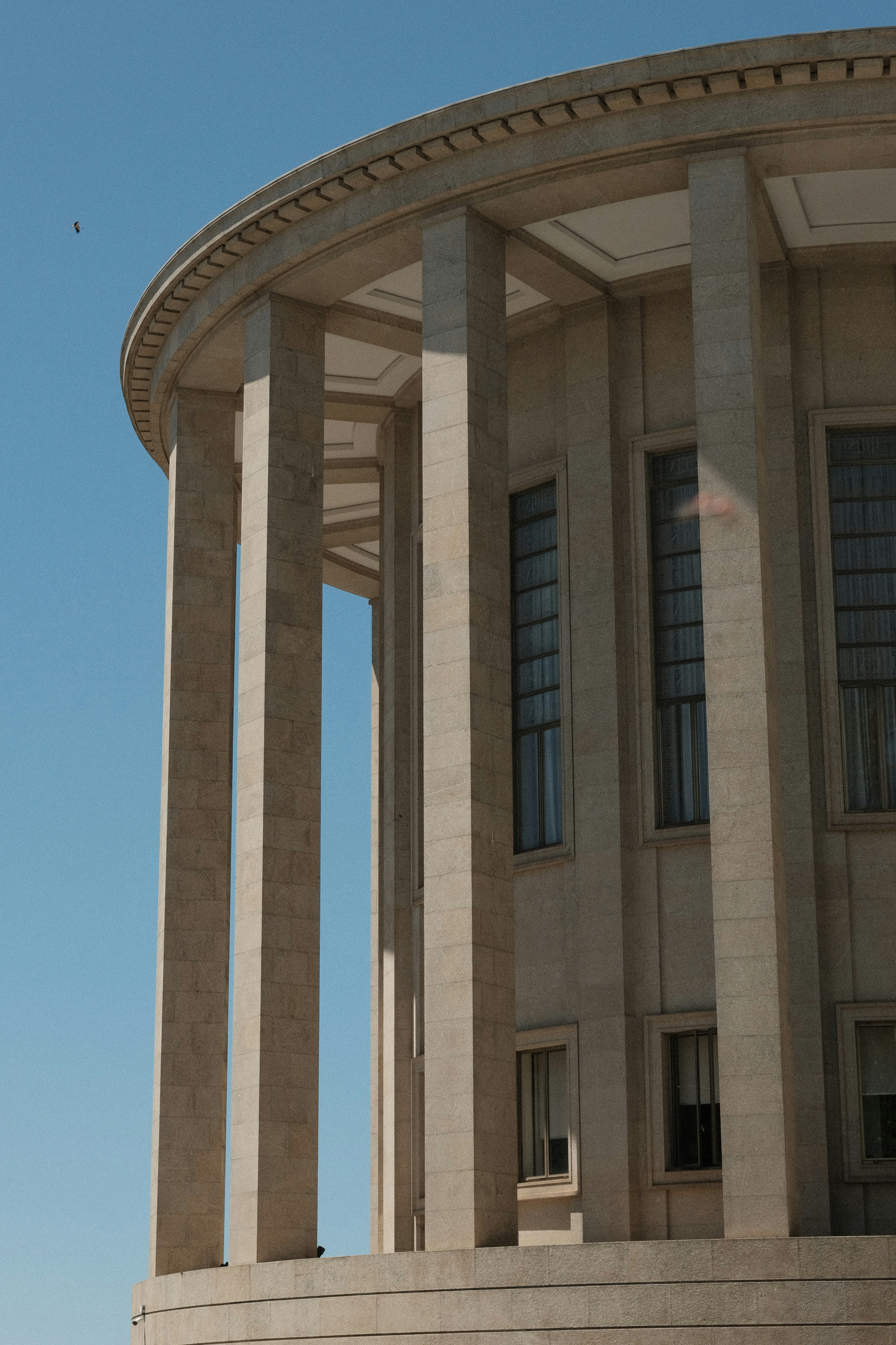 Sunlit Colonnade: Vertical Grace of a Circular Temple