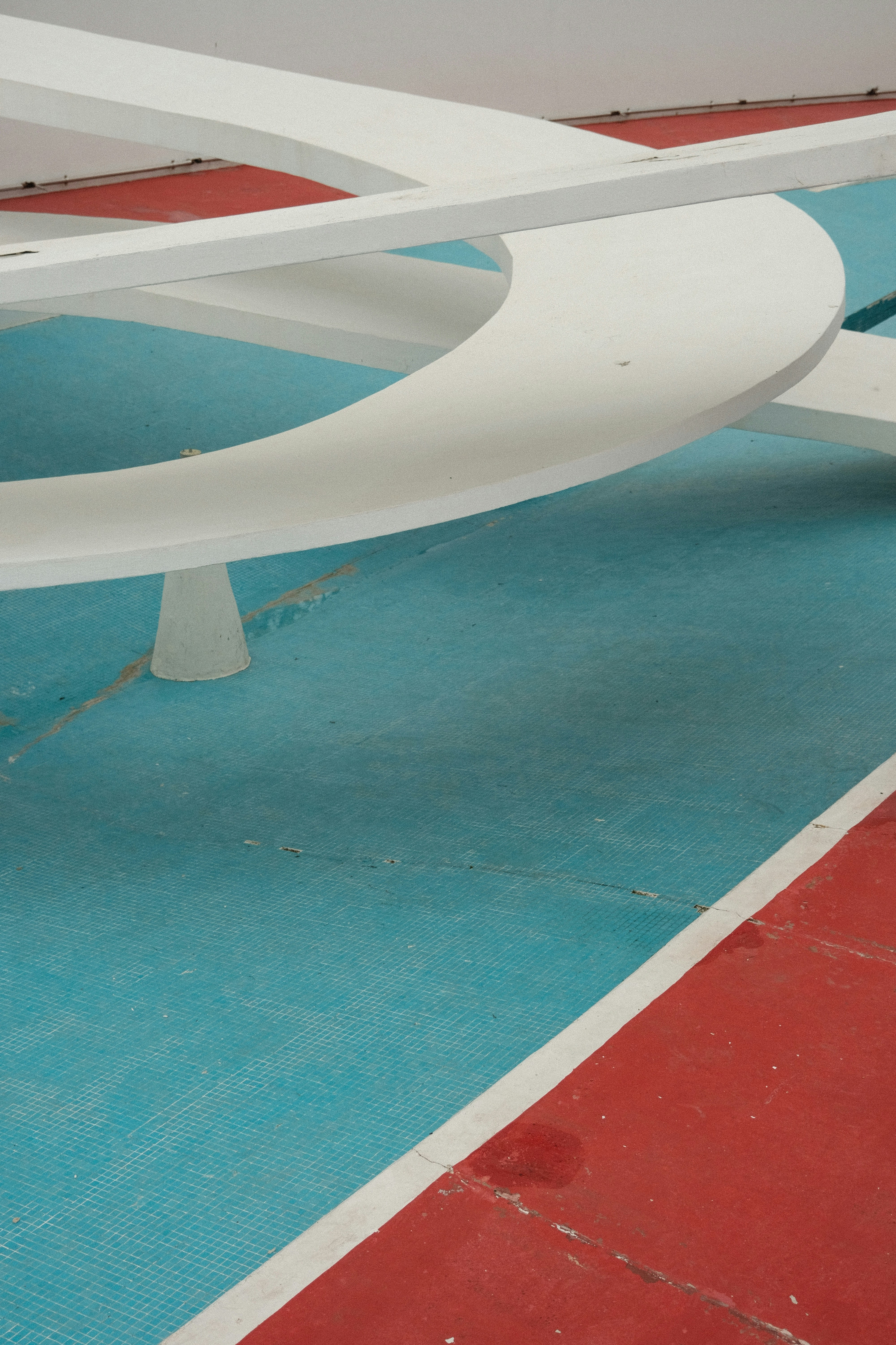 Interwoven White Ribbons Over a Cyan-Red Playground