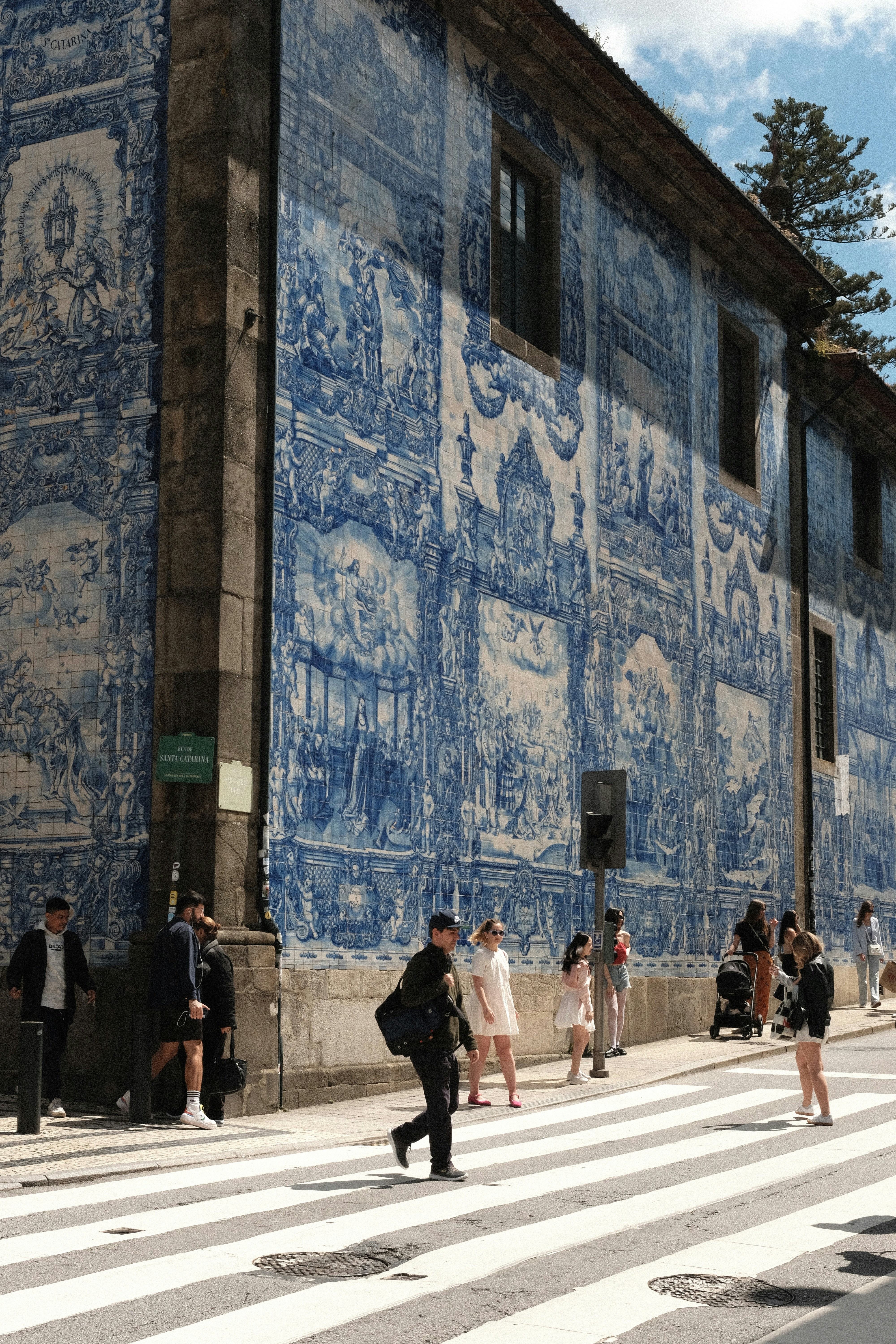 Azulejo Chronicle: Pedestrians Cross a Wall of Blue Tiles