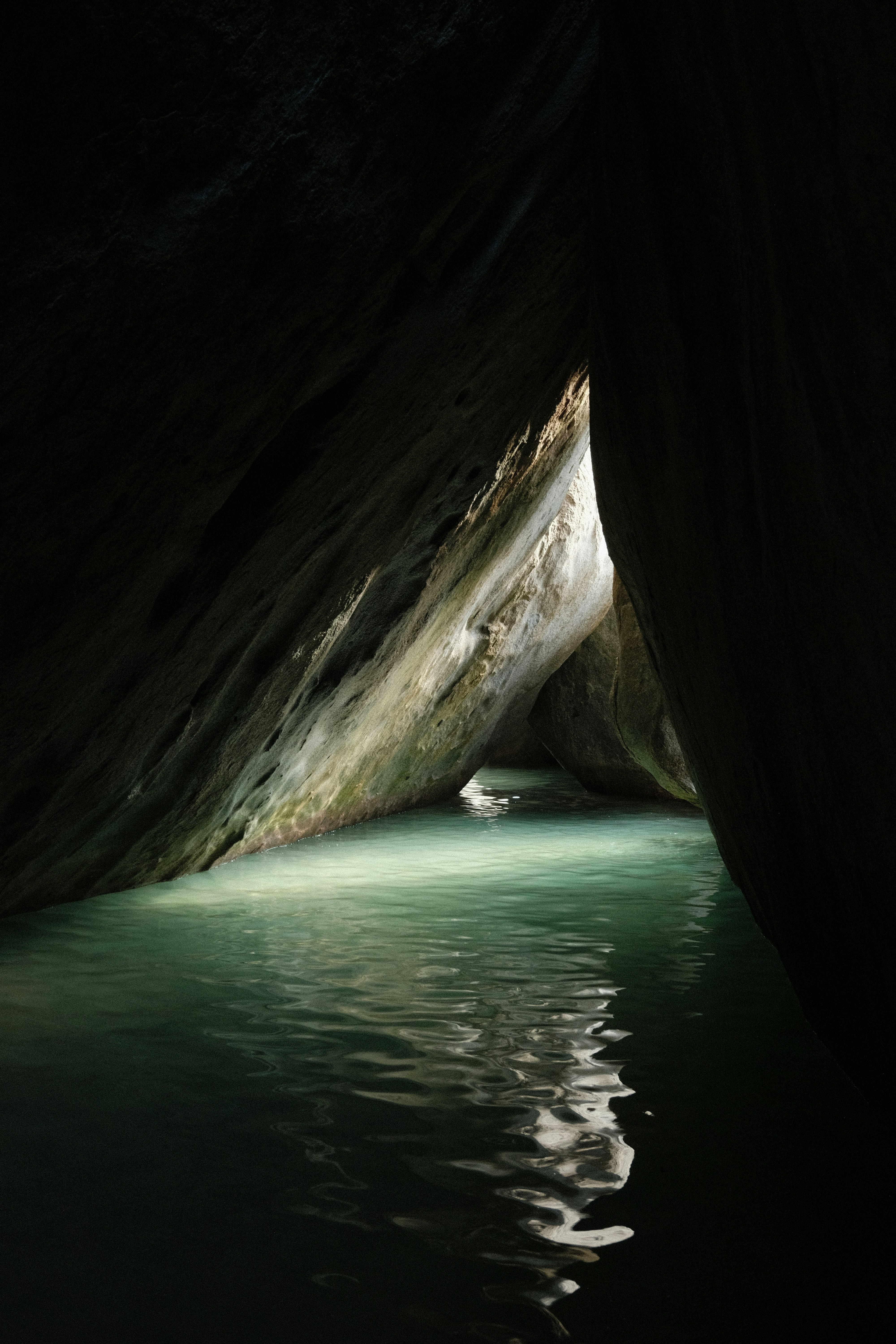 A large cave with a body of water inside of it photo – Free Nature ...