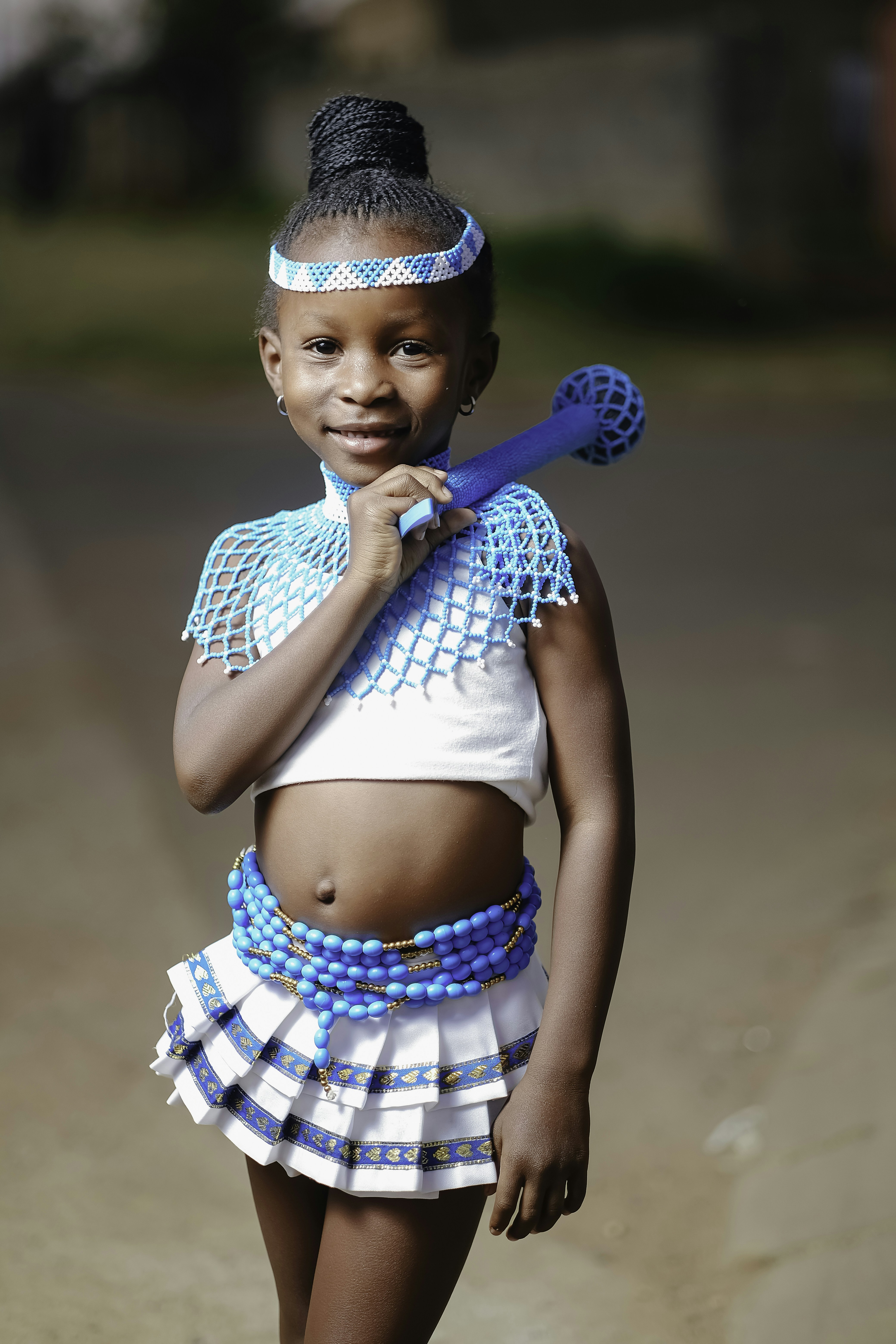 A young girl in a blue and white costume photo – Free Face Image on ...