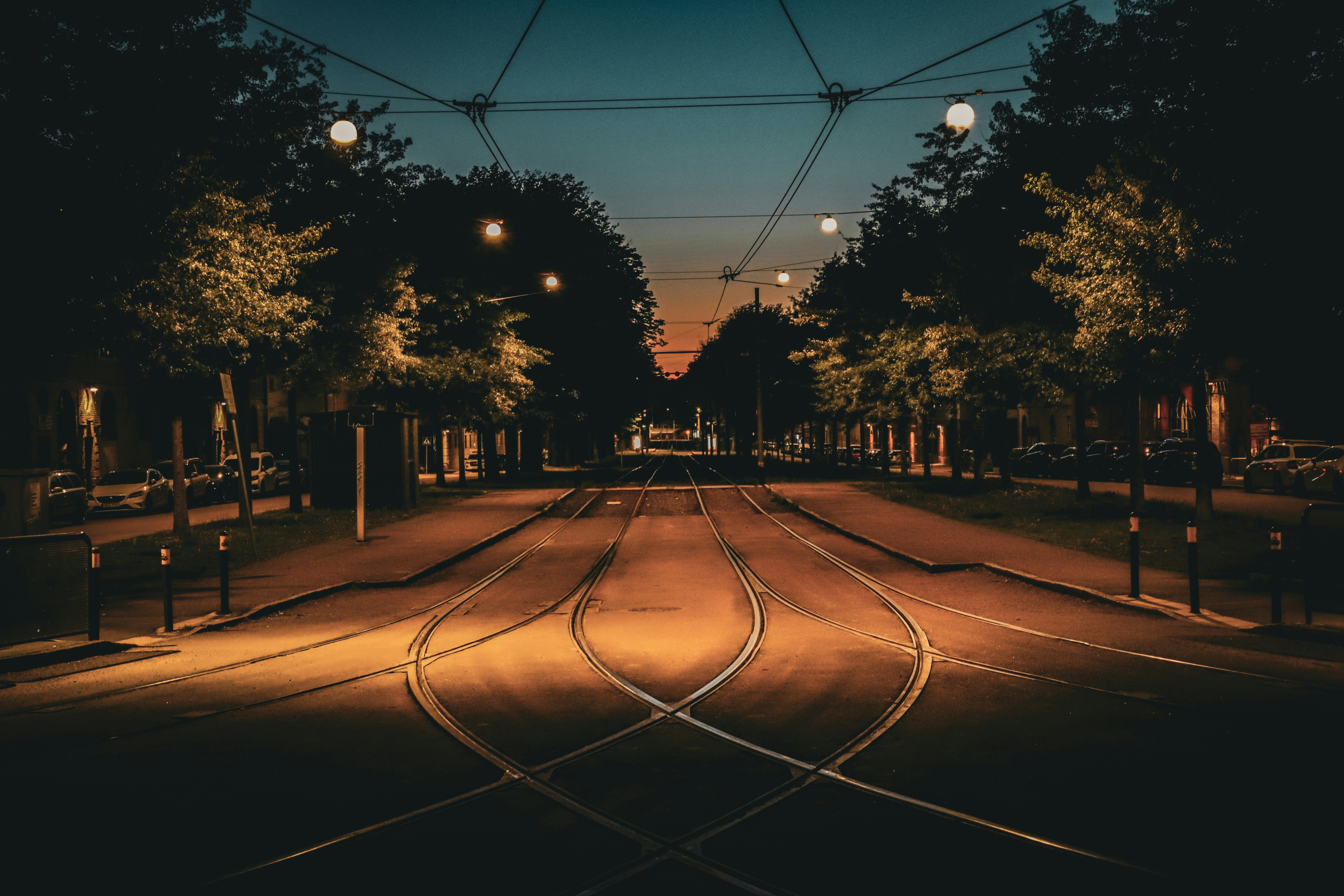A train track at night with lights on photo – Free Sweden Image on Unsplash