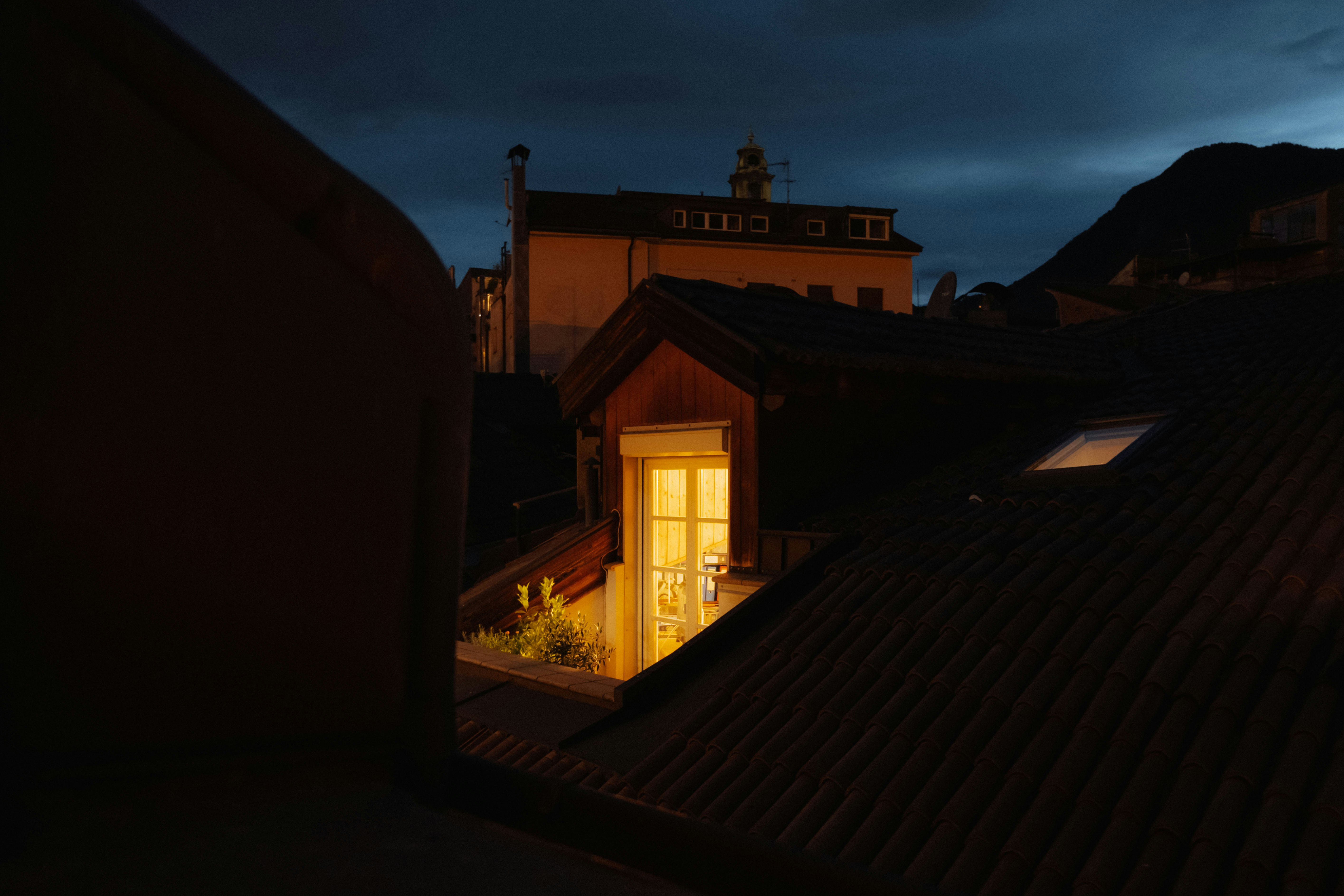 A view of a building from a rooftop at night photo – Free Bolzano Image ...