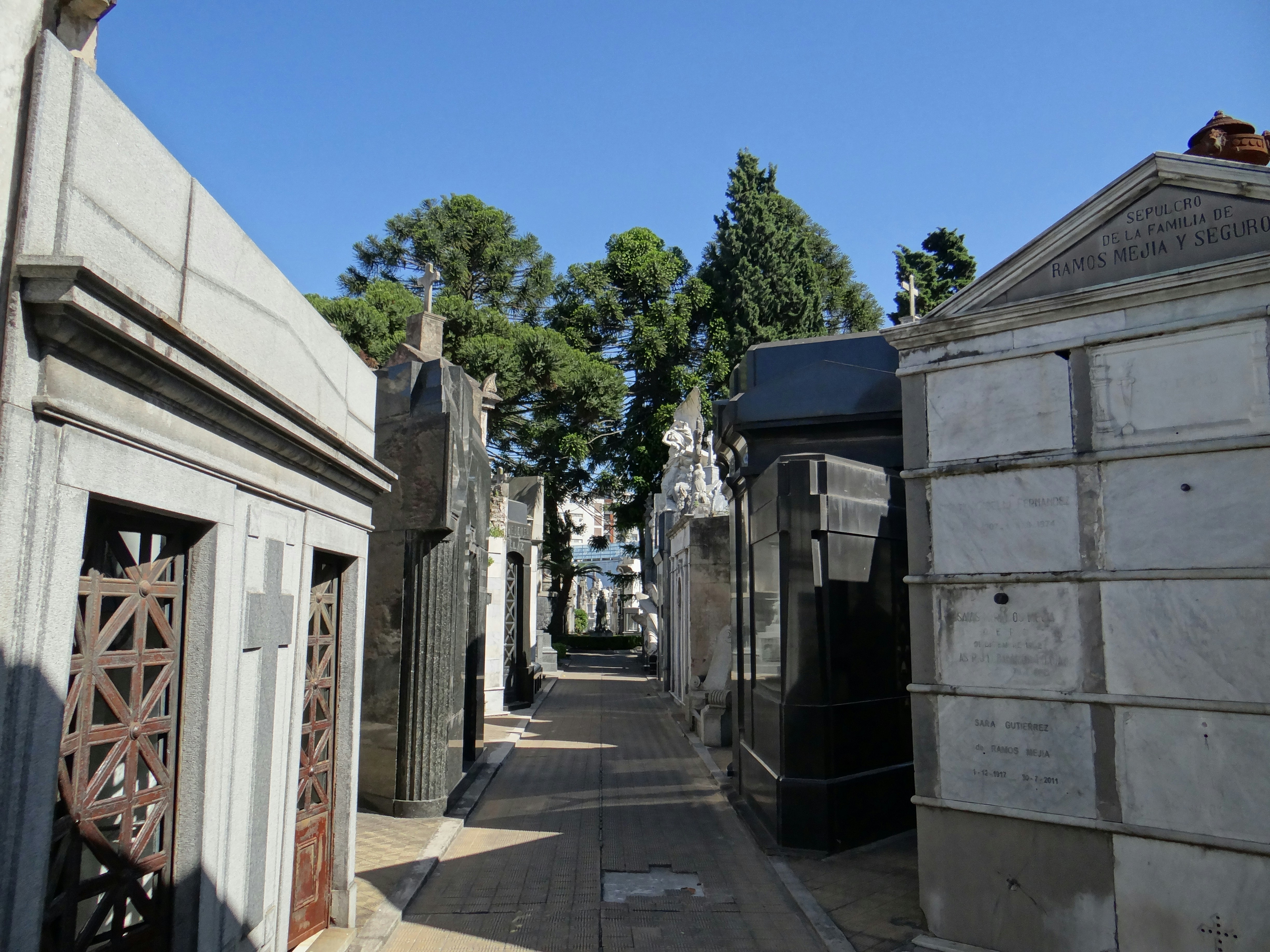 Sunlit Aisle Between Stone Monuments