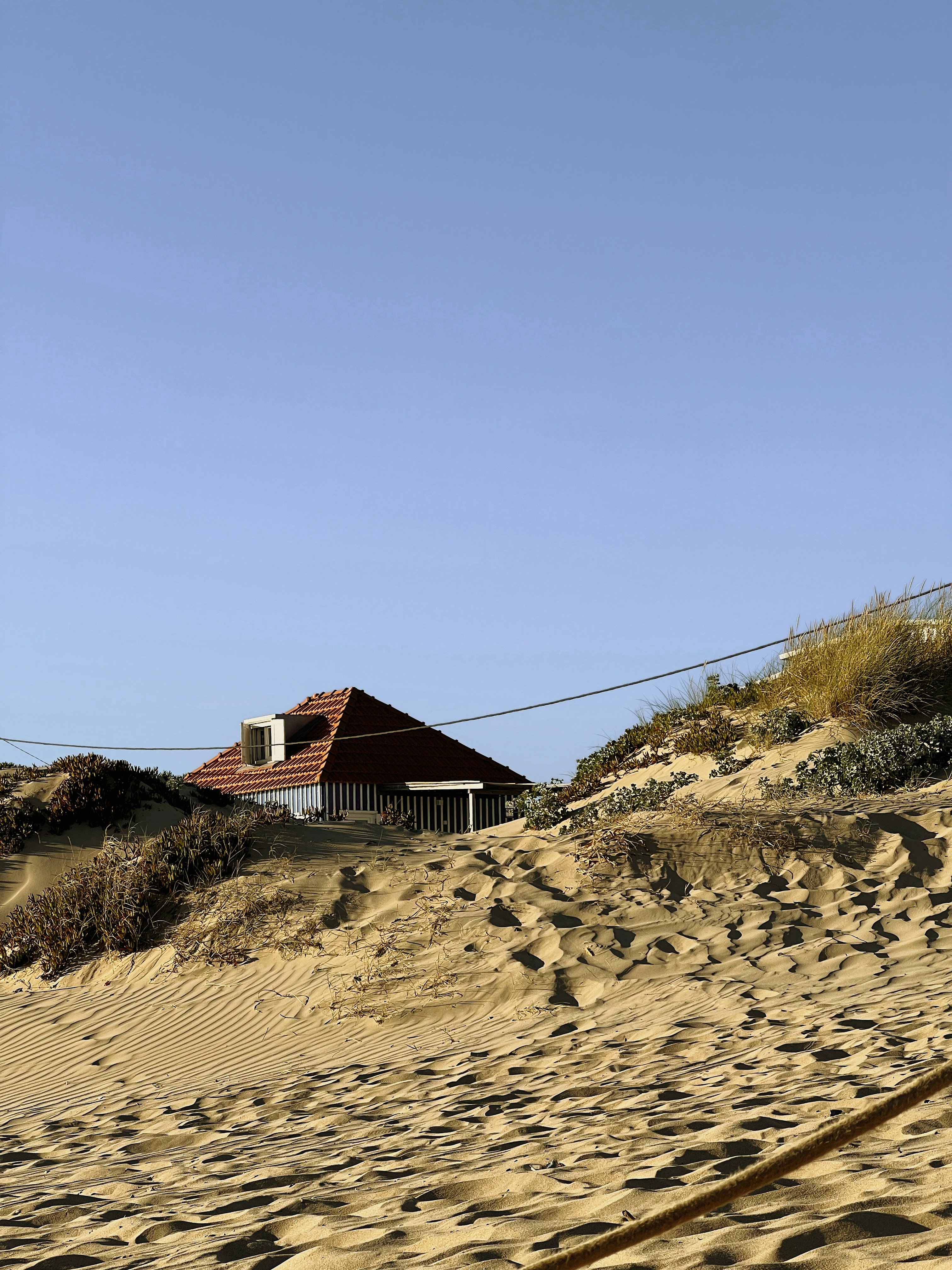 Dune Shelter: A Red-Tiled House on the Wind-Swept Shore