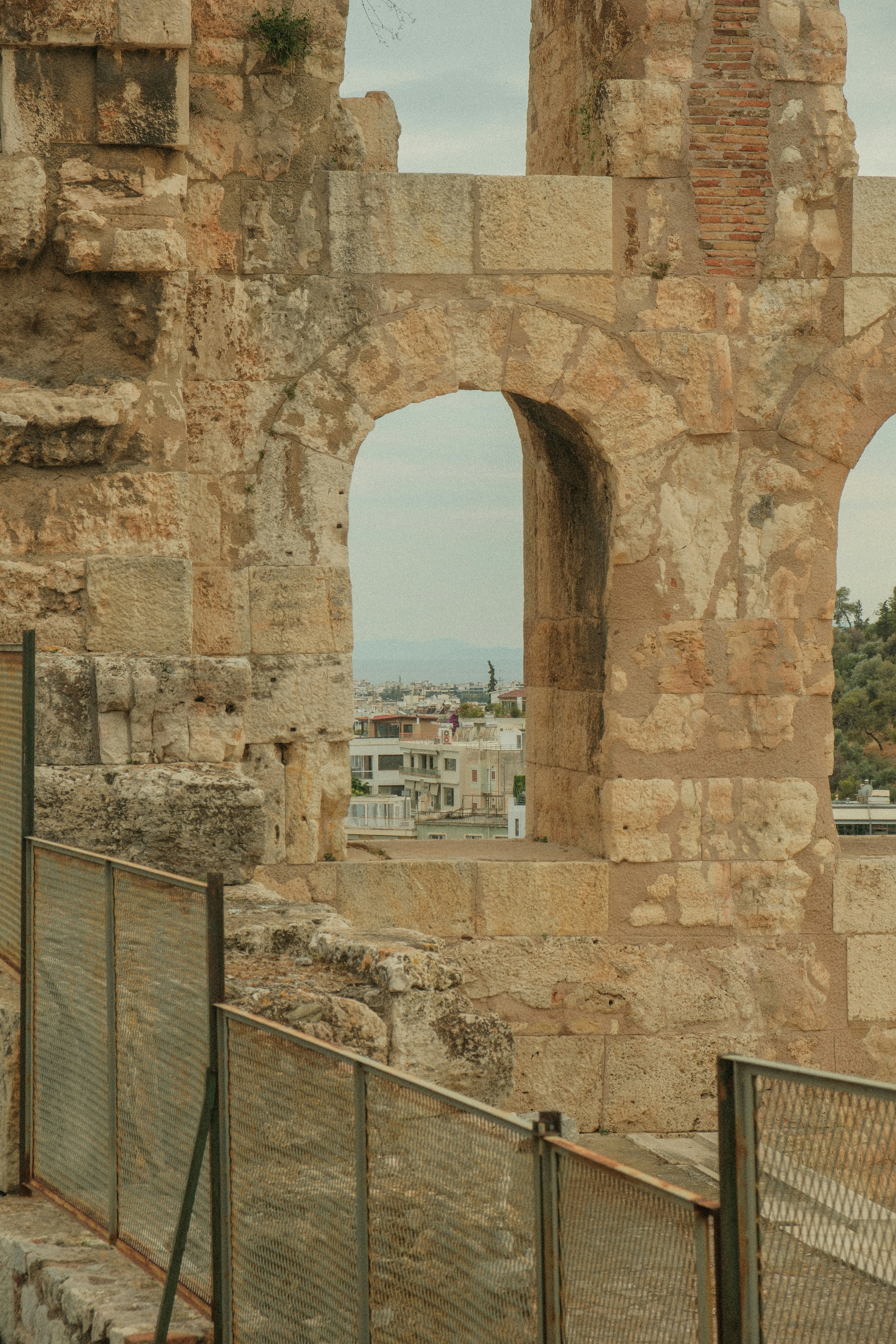 Through the Arch: A Quiet Town Framed in Weathered Stone