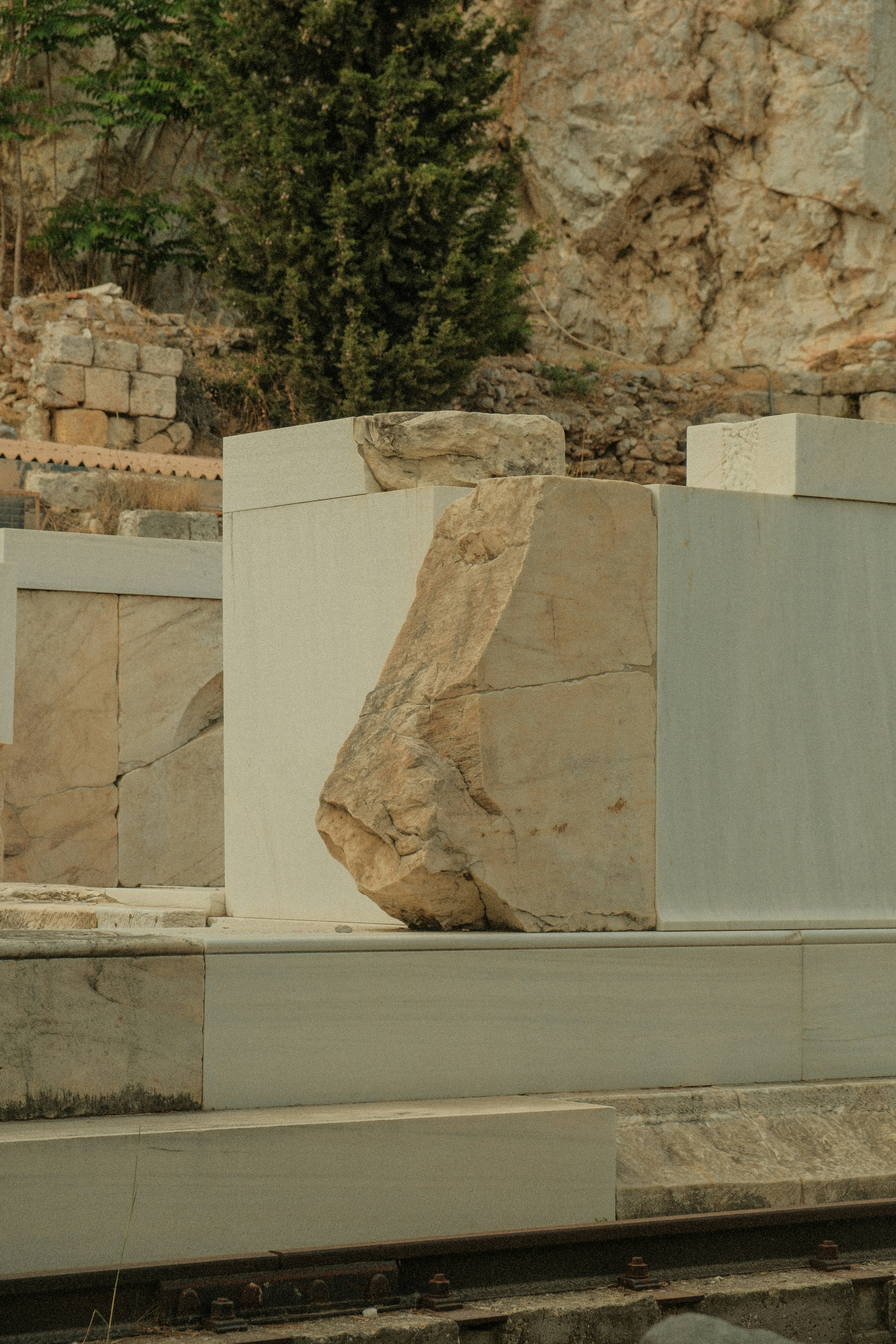 Monolith on Pale Terraces: A Stone Block Among Geometric Concrete Blocks
