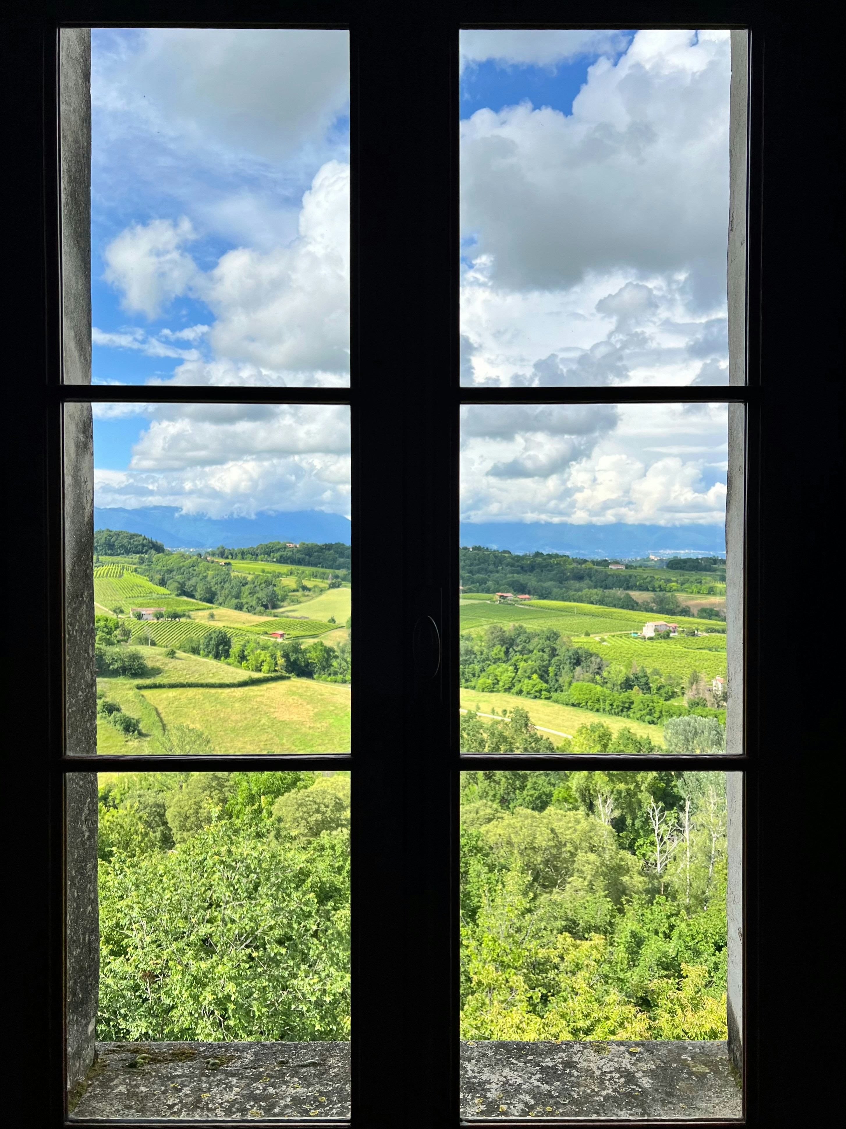 Verdant Valleys Framed by a Rustic Window