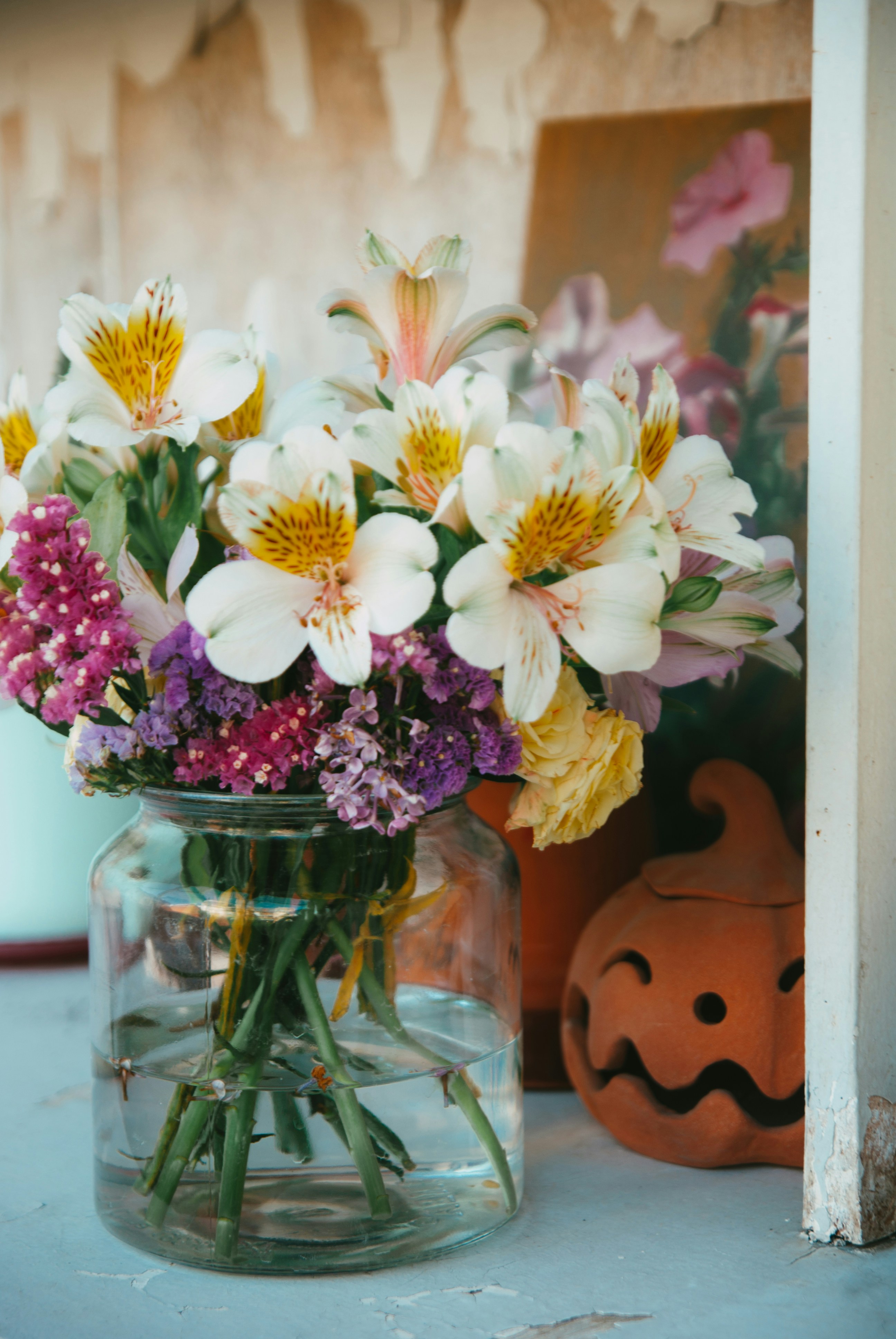 Vibrant Bouquet in a Glass Jar with Halloween Lantern Backdrop