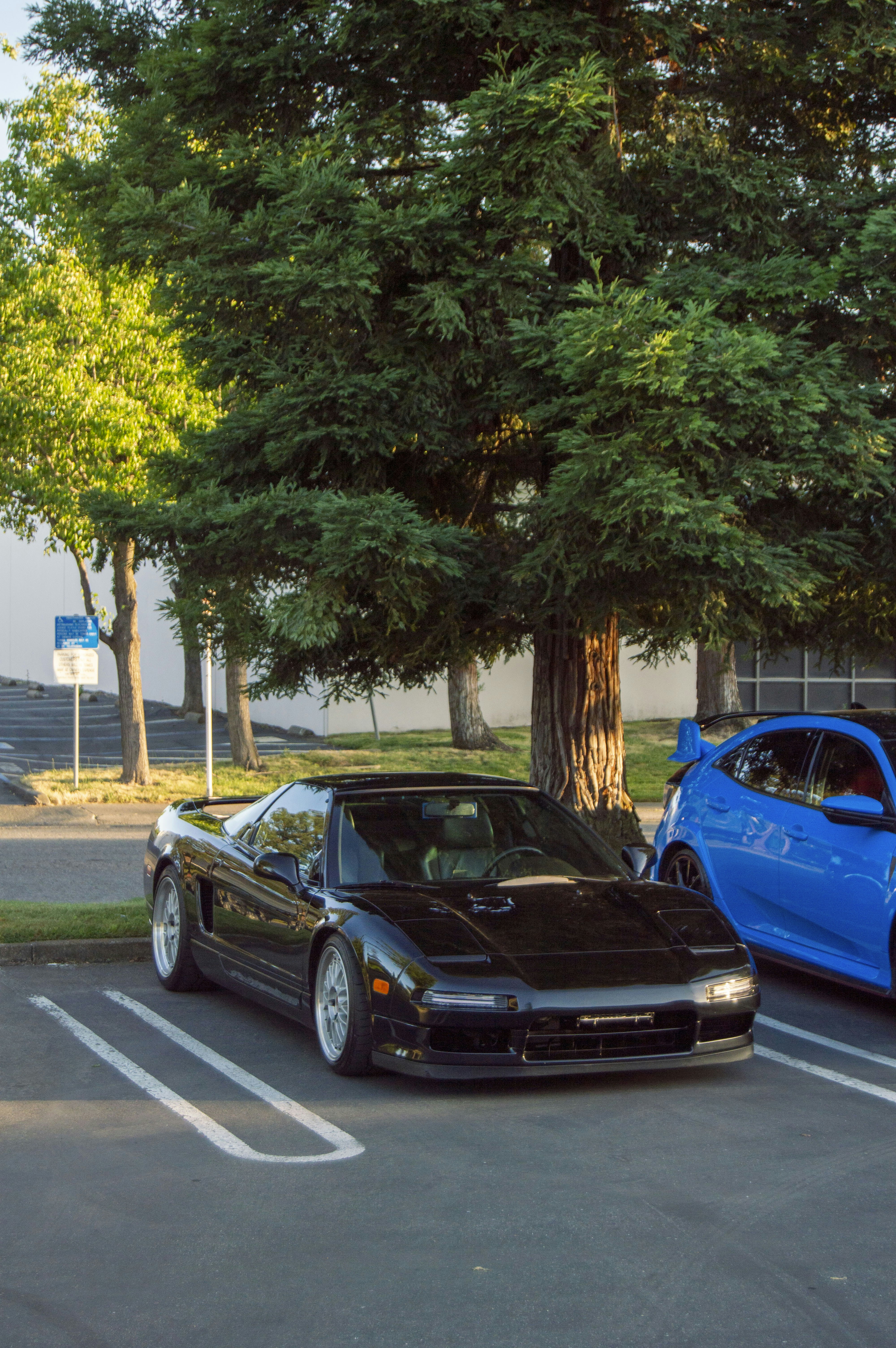 Two cars parked next to each other in a parking lot photo – Free ...