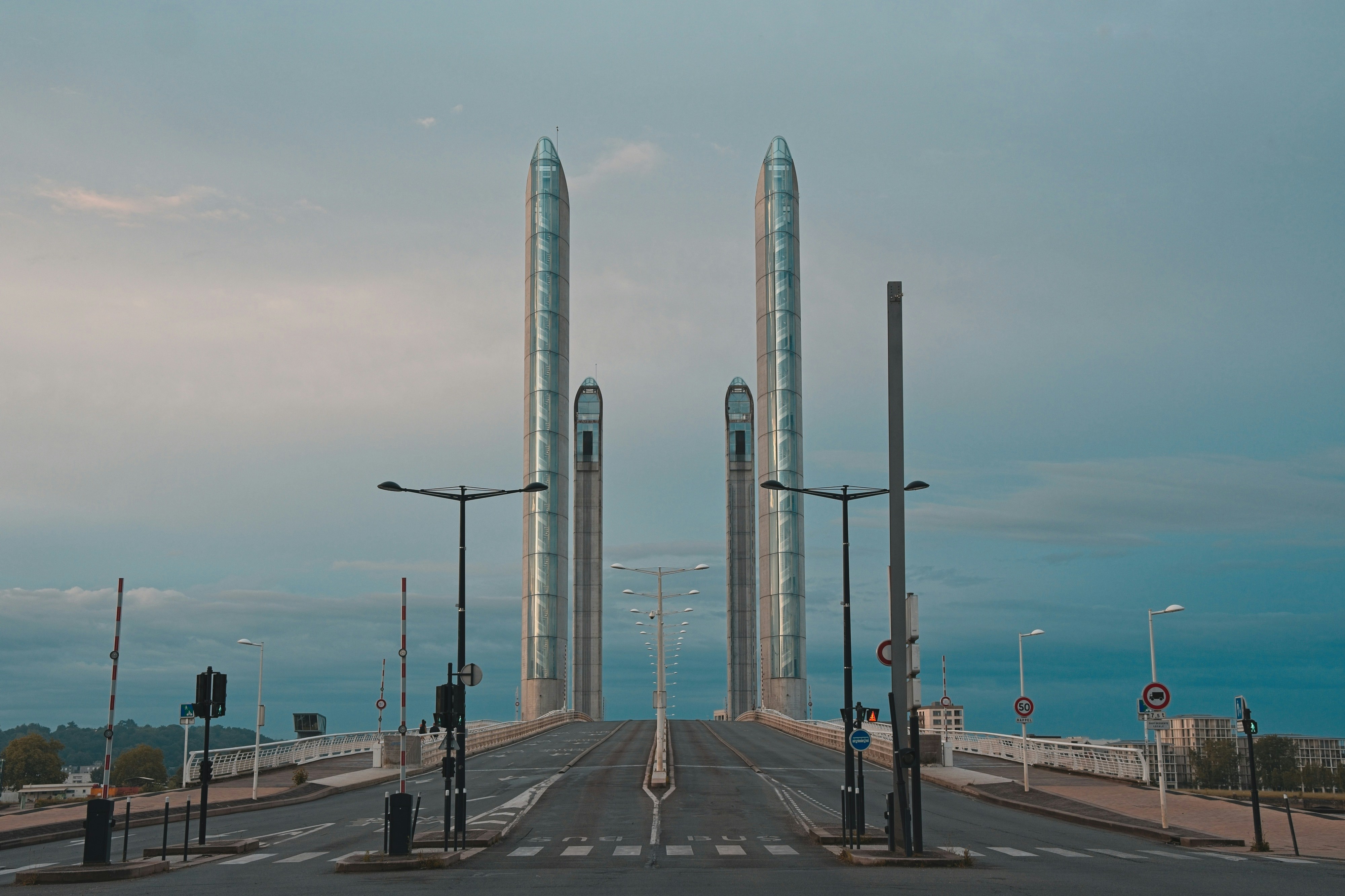 Toward the Vanishing Point: The Four Pillars Framing a Quiet Bridge Approach