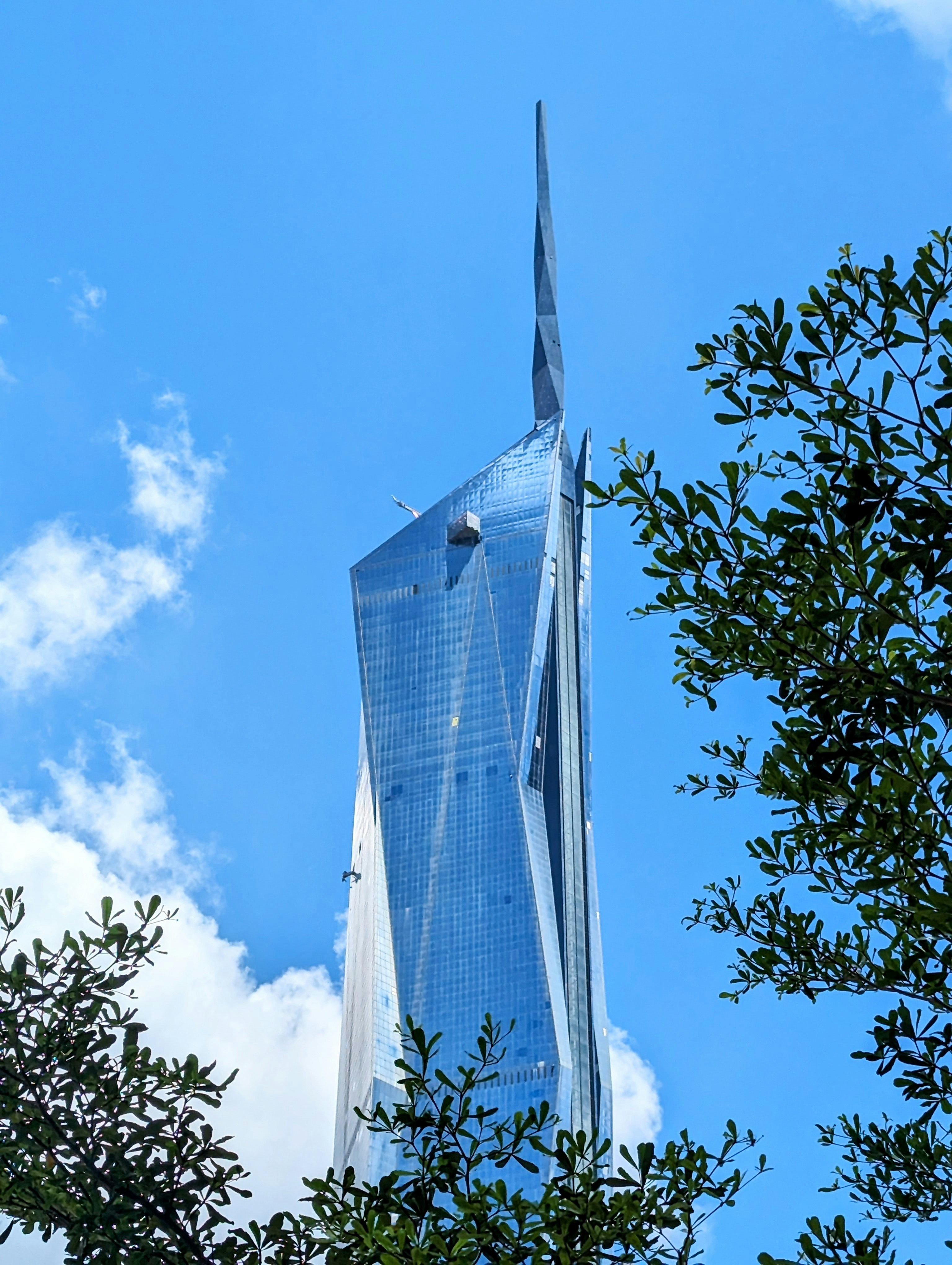 A very tall building with a very tall spire photo – Free Blue Image on ...