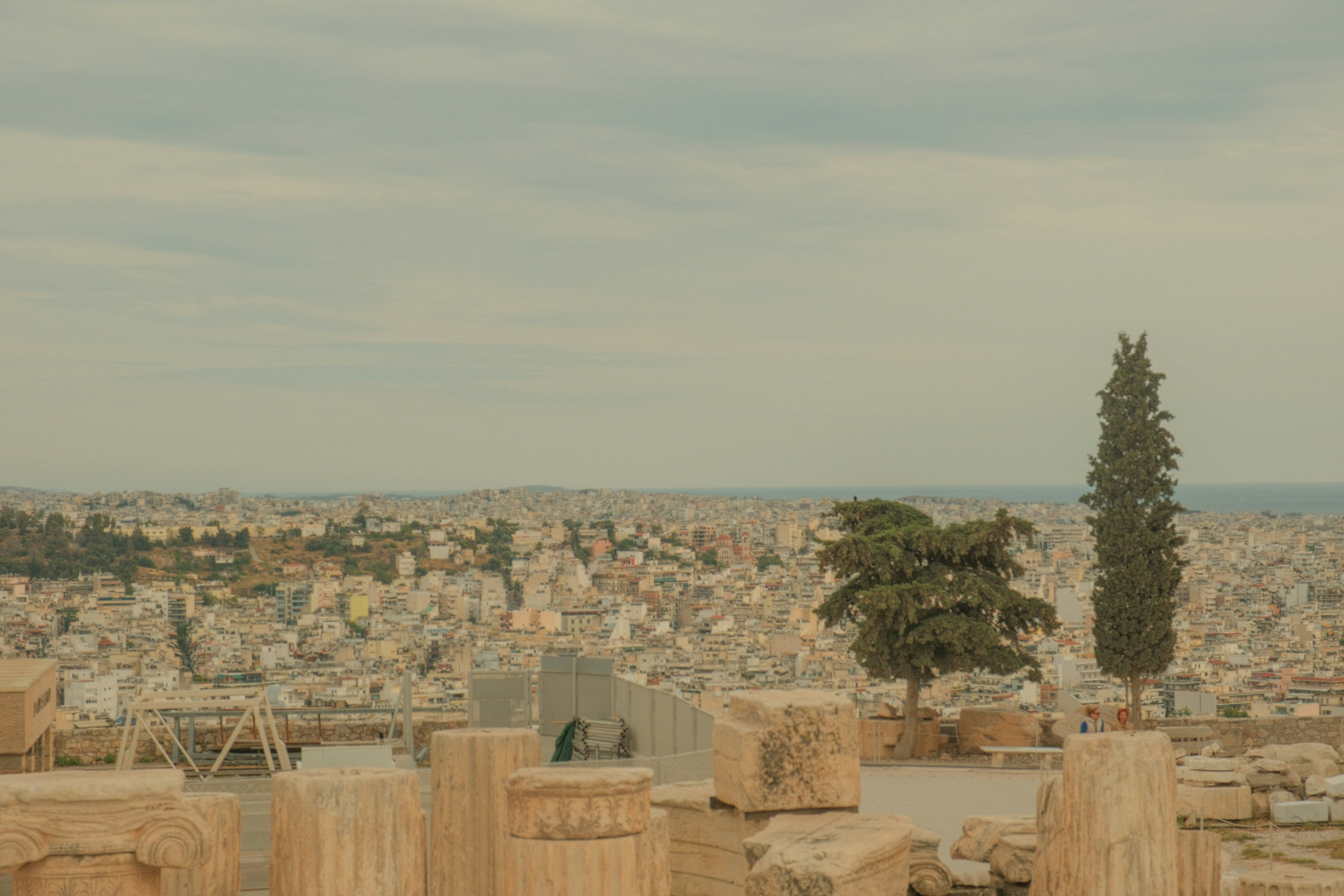 Timeworn Stones Framing a Quiet Cityscape Under Pale Light