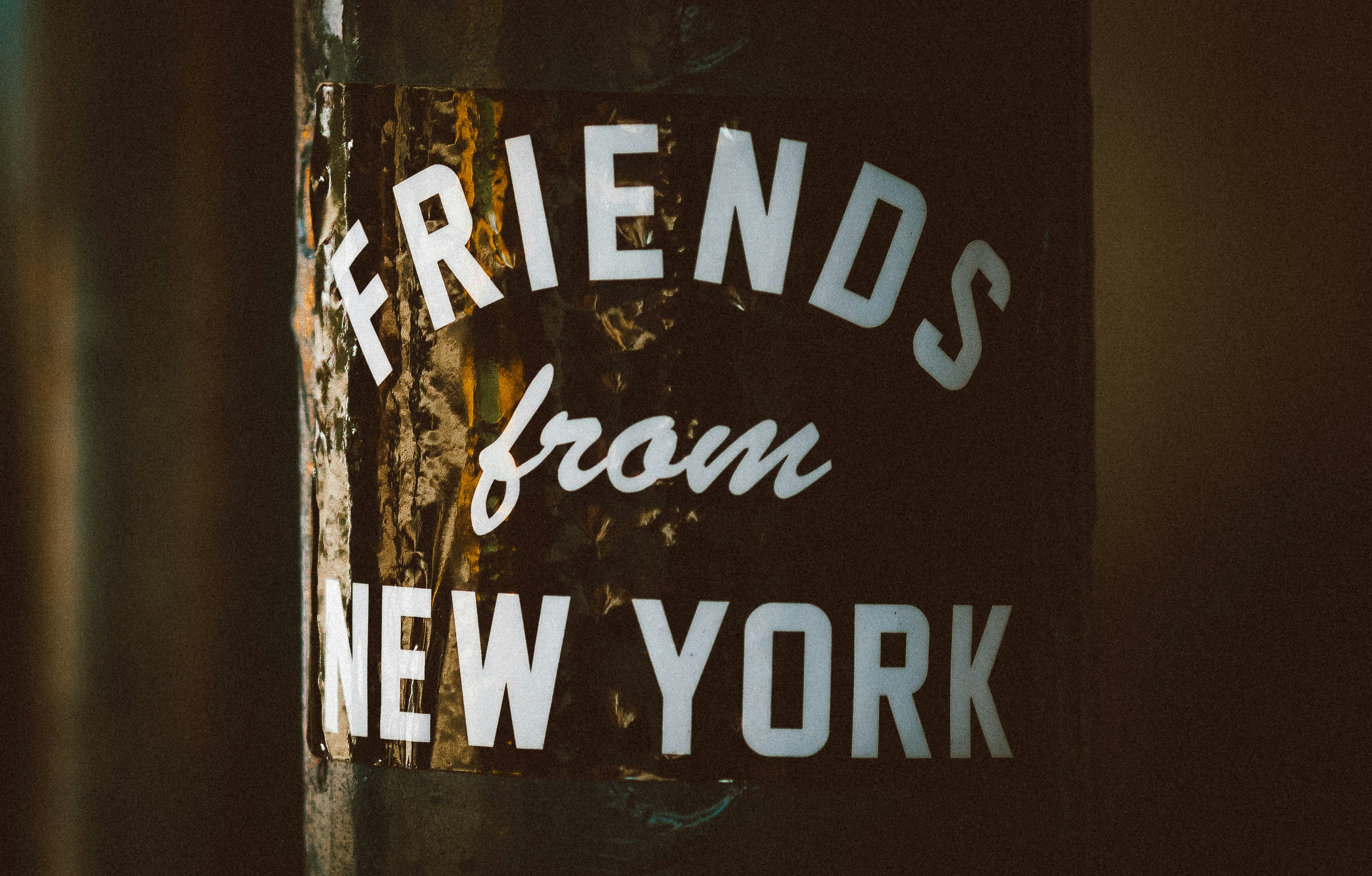 New York Mural Inscription on Weathered Signpost