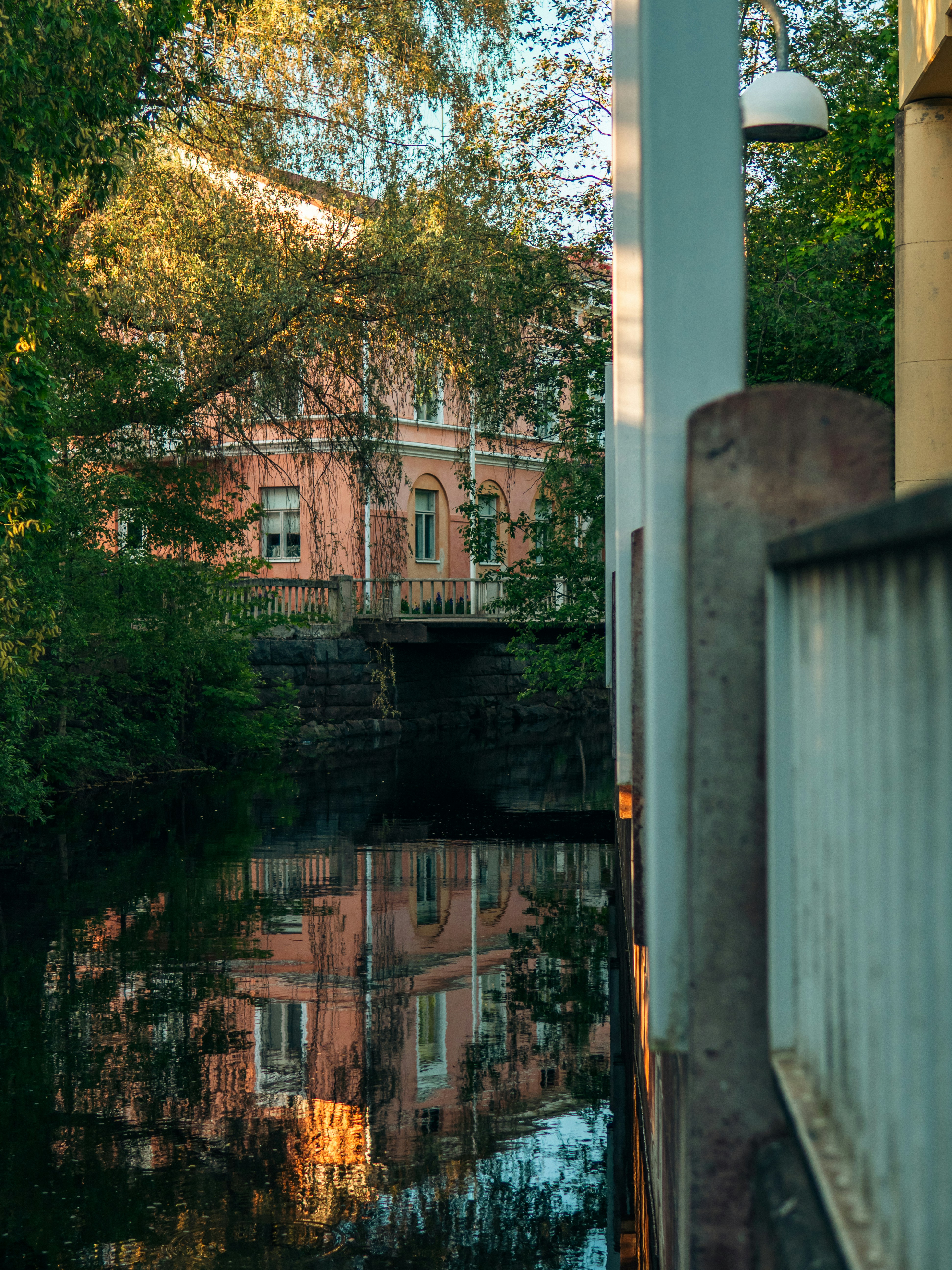Reflected Peach: a Quiet Canal Scene Framed by Railings
