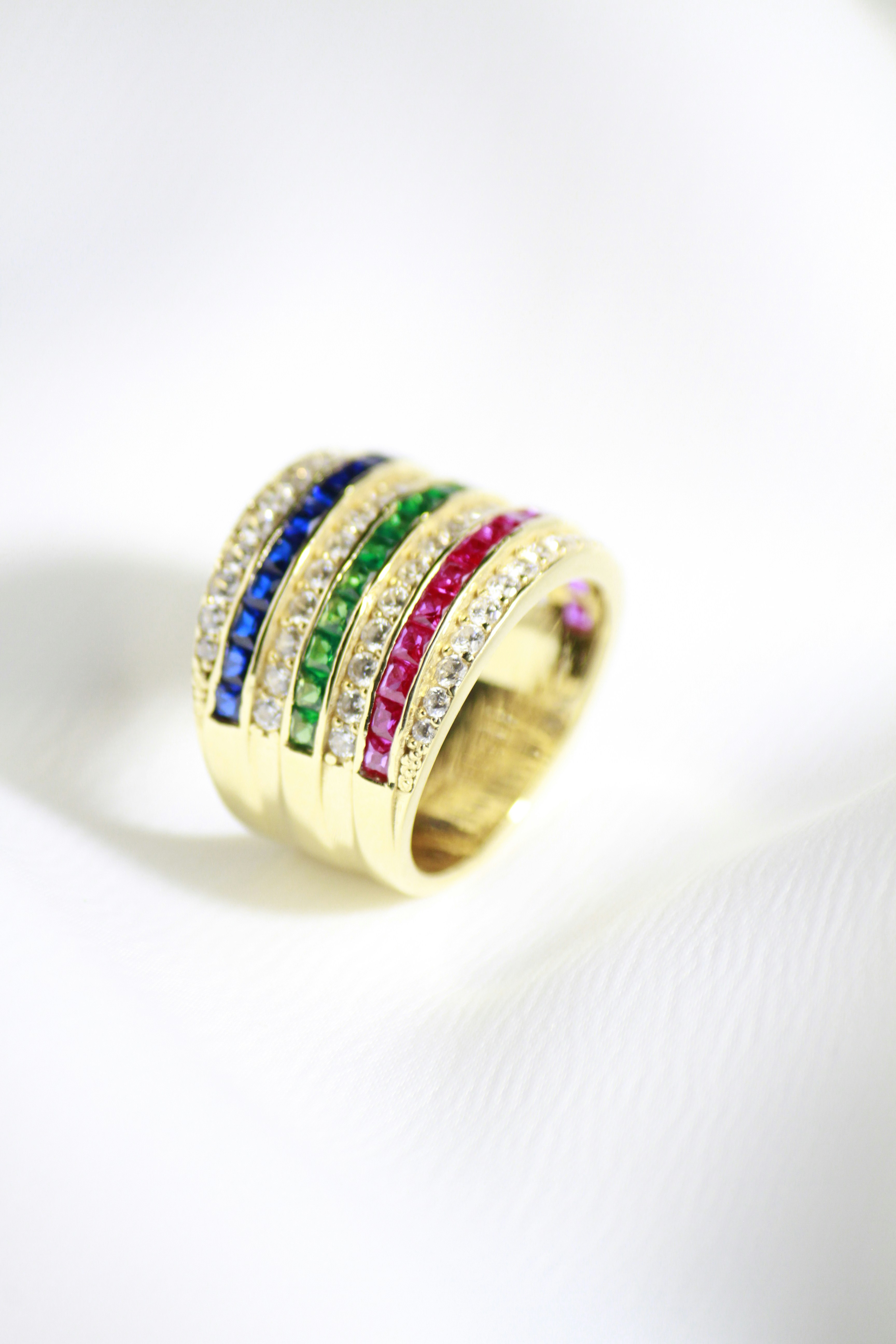Aurora Ring: Gold Band with Rainbow Gemstones in Close-Up Studio Light