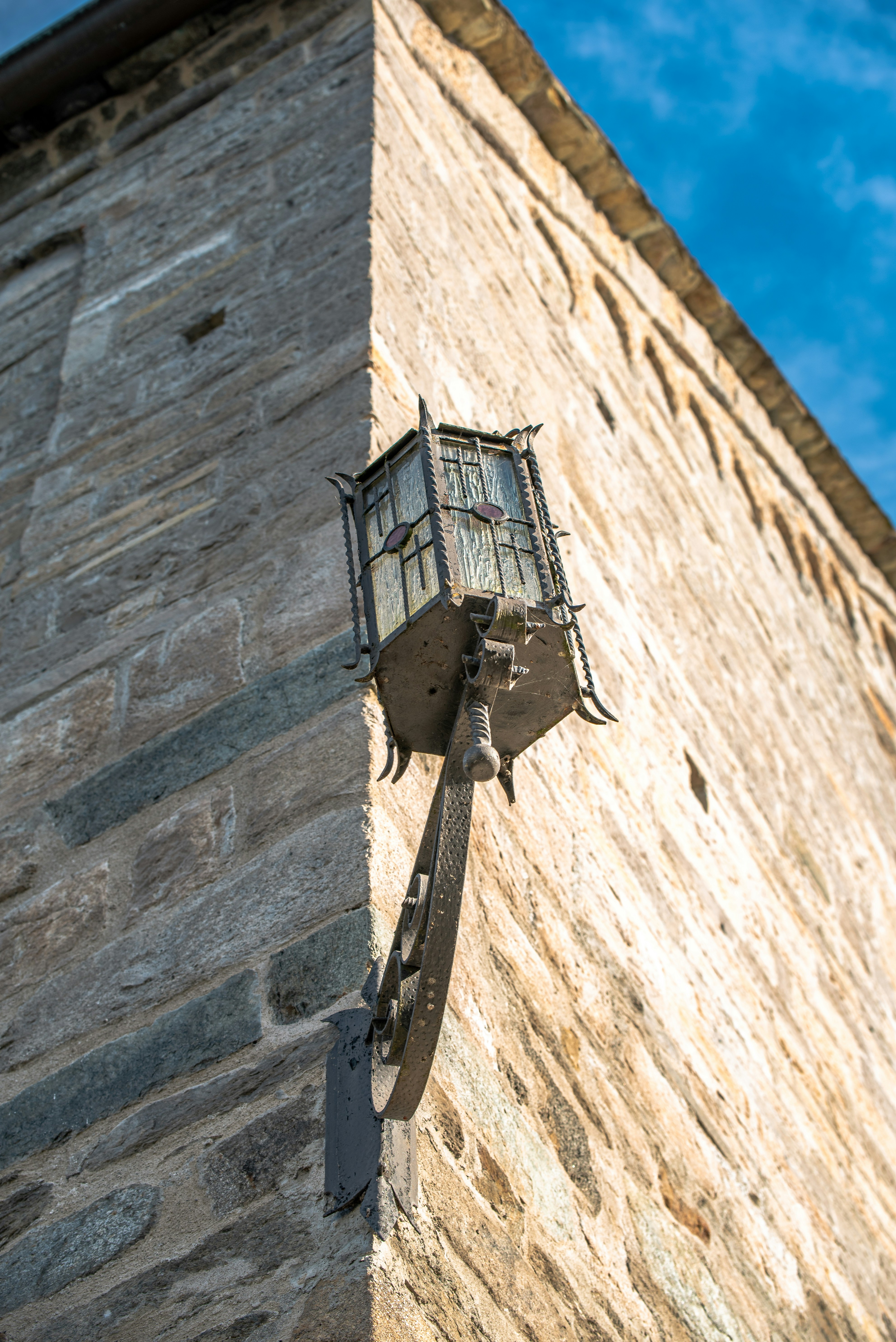 Iron Lantern Clinging to Time-worn Stone