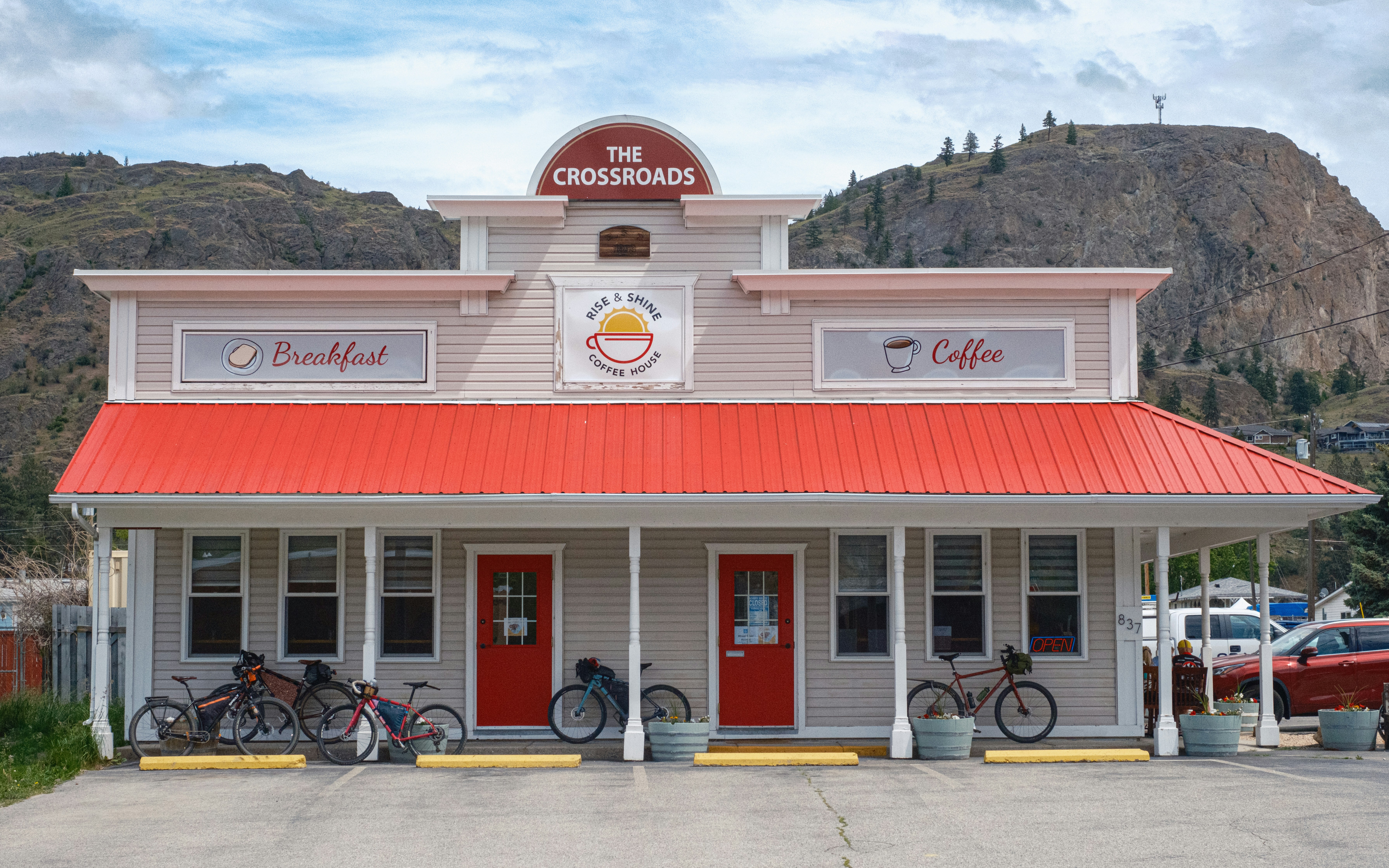 The Crossroads Diner: Red Roofs and Hillside Charm
