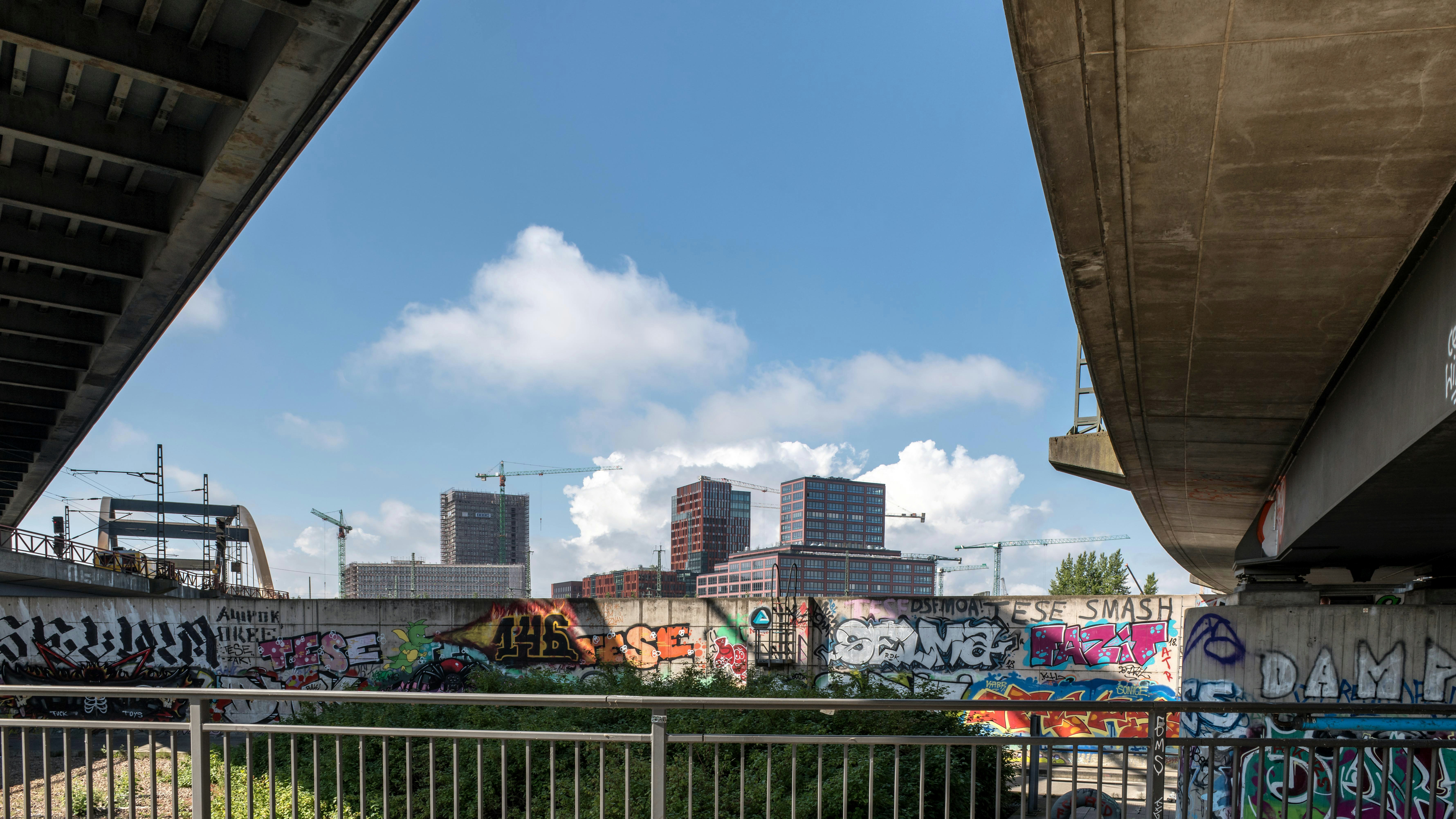 Concrete Canvas: Vivid Graffiti Spanning an Overpass Against a Clear Urban Sky