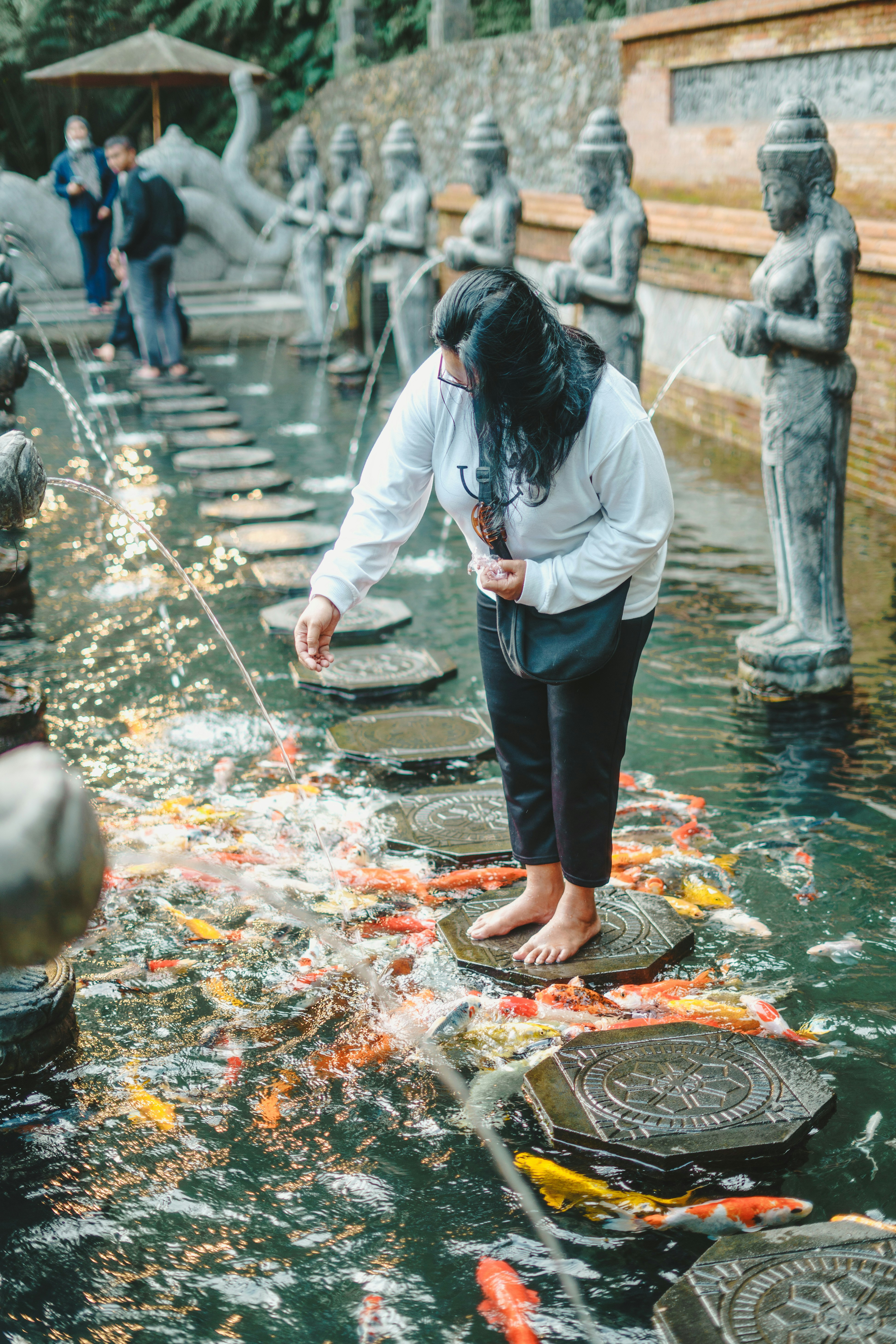 Footsteps Across the Koi Courtyard: A Quiet Moment by the Guardian Statues