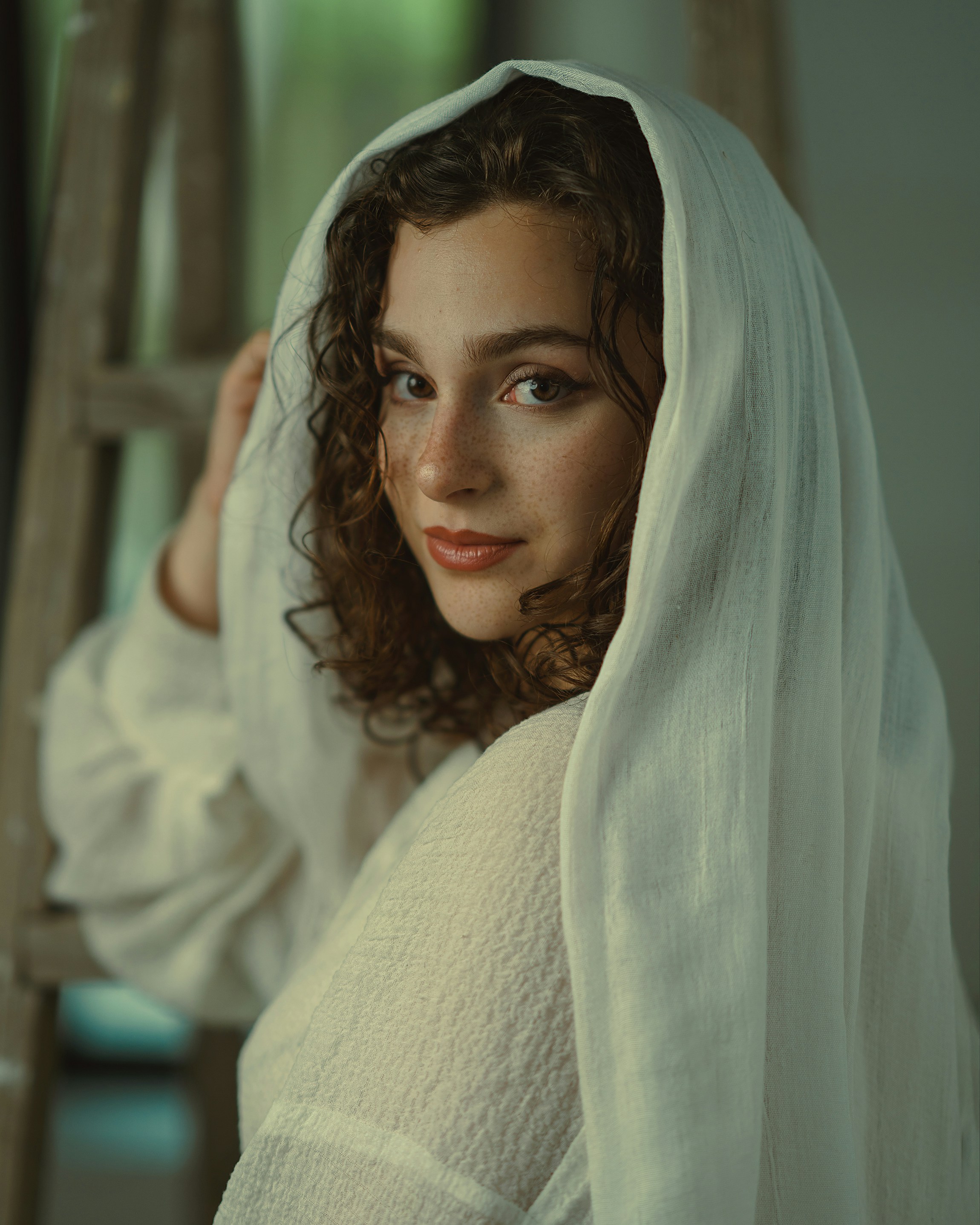 A woman in a white robe sitting on a ladder photo – Free Portrait Image ...