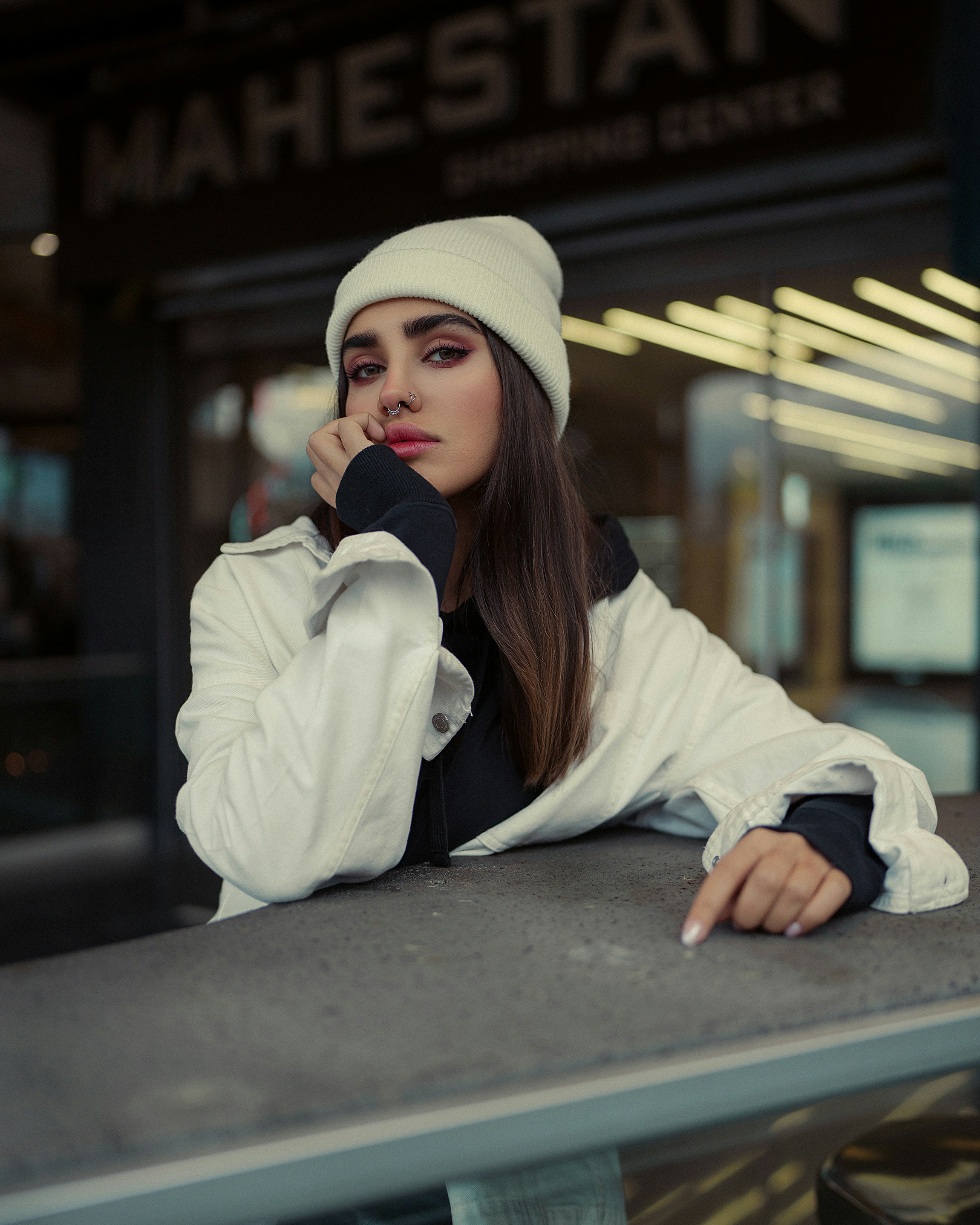 A woman leaning on a counter with her hand on her face photo – Free ...