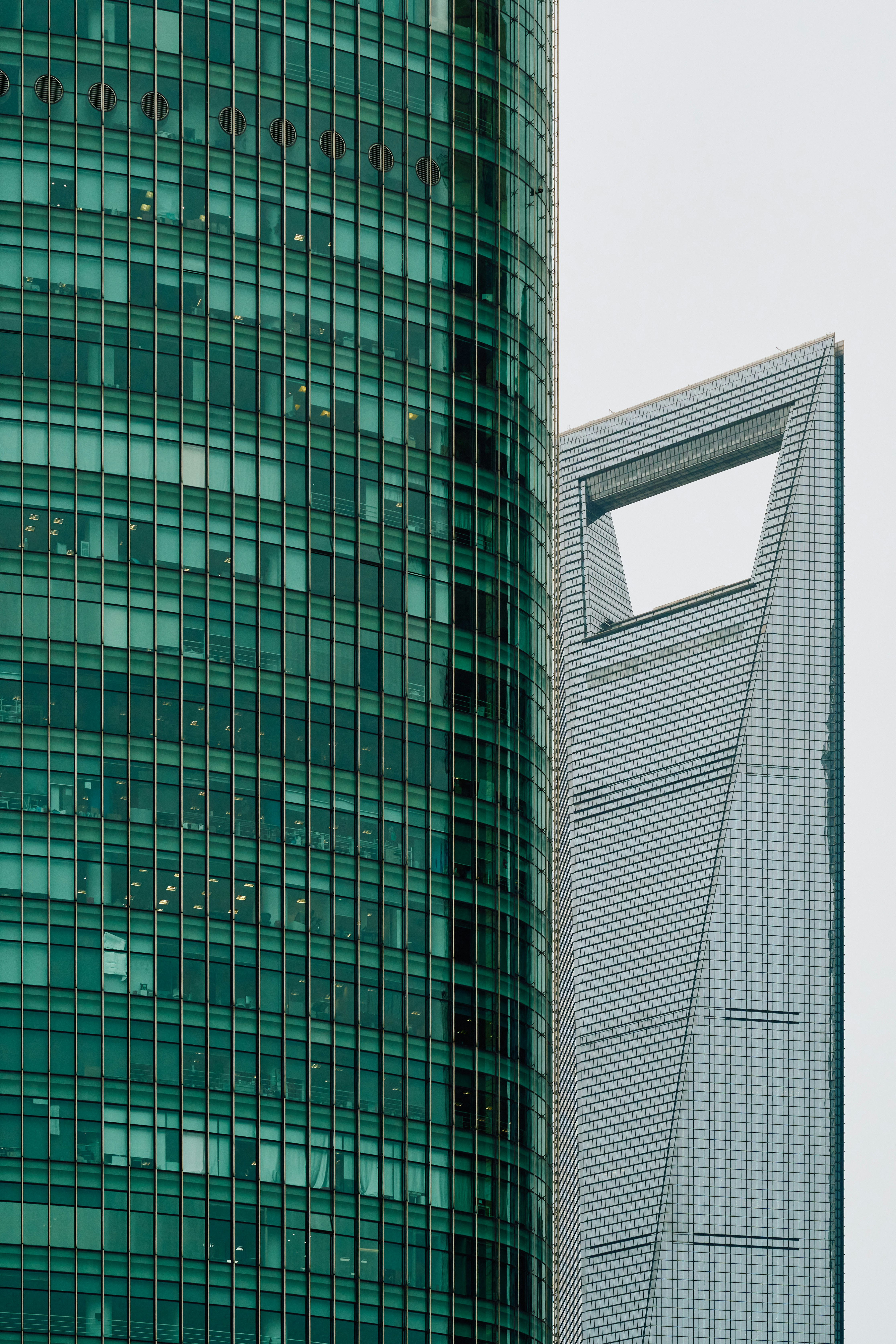 Framed Void Between Emerald Glass and Pale Facade