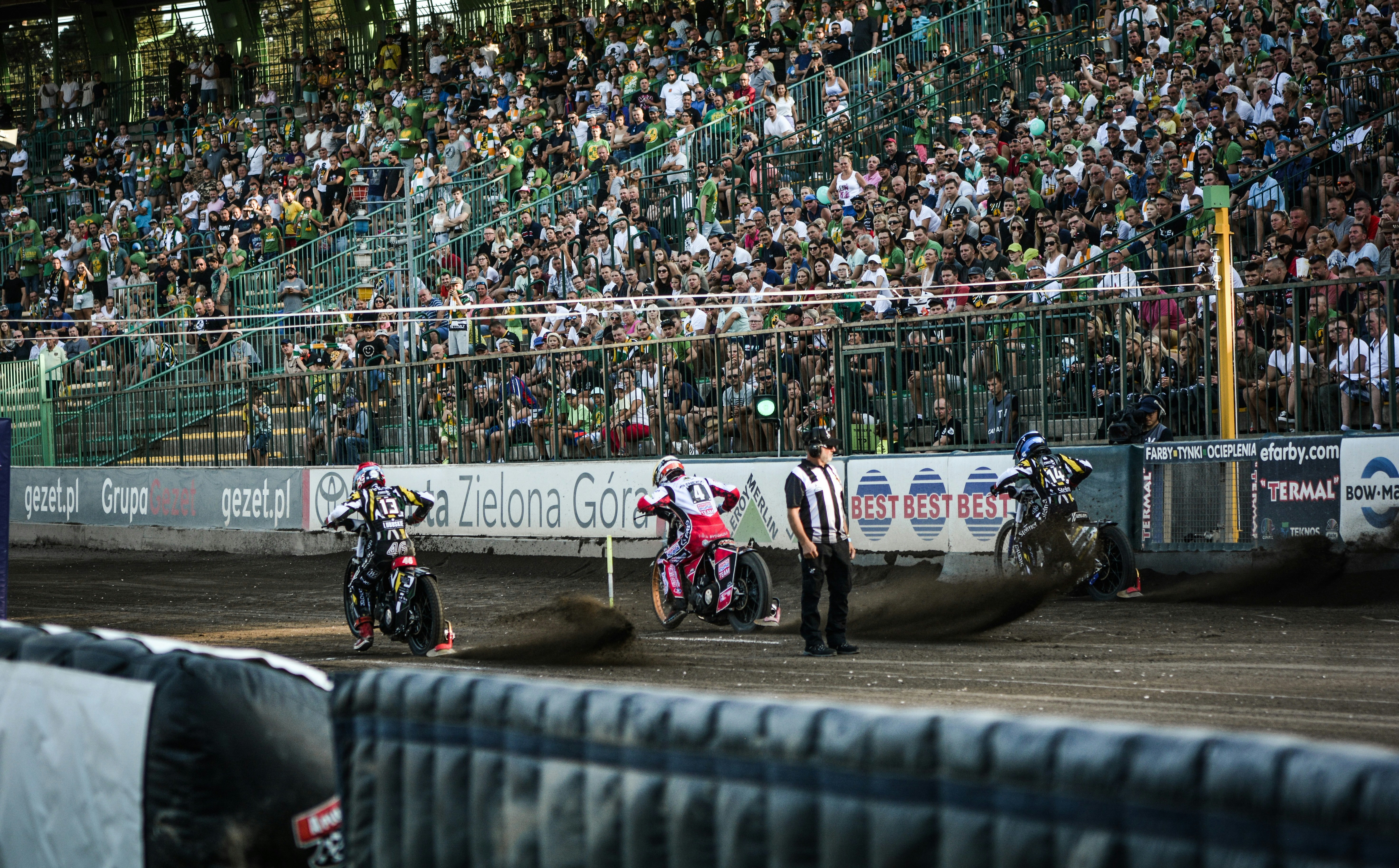 A group of people on dirt bikes in front of a crowd photo – Free ...