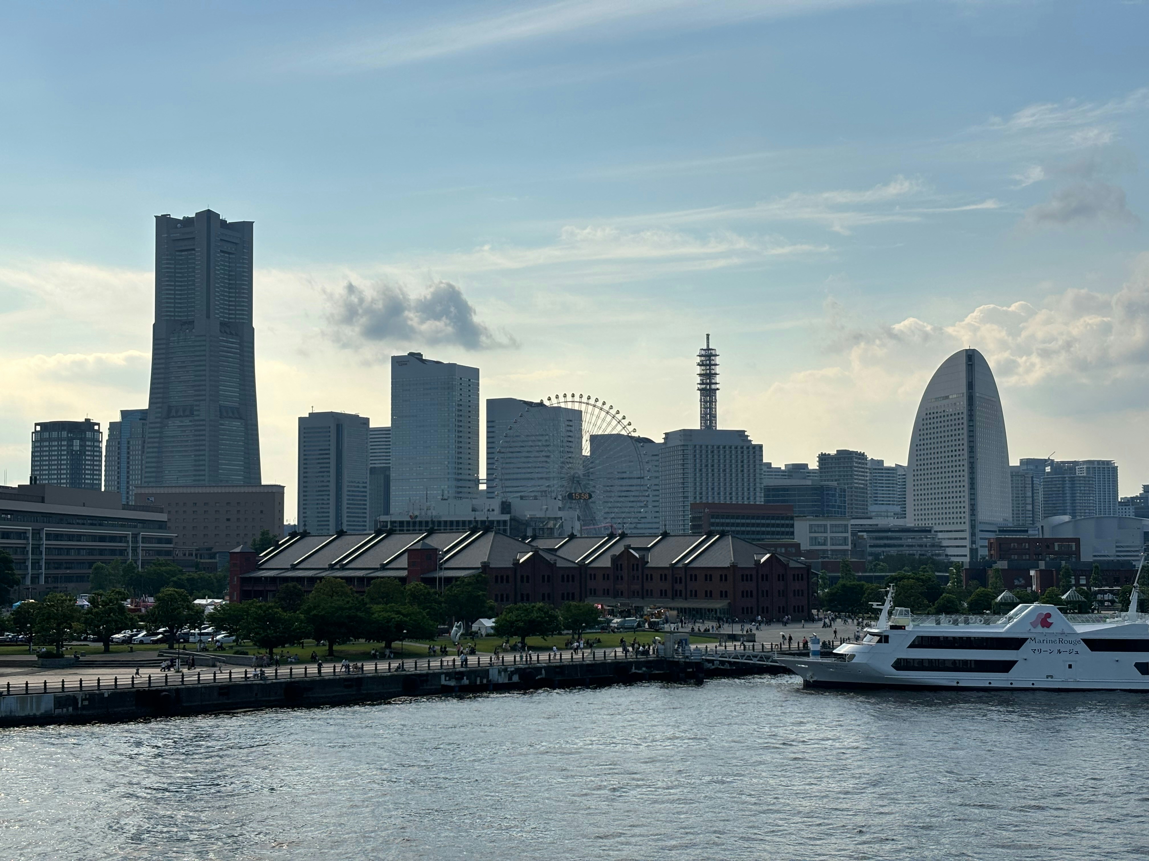 Horizon in Steel and Sail: Skyline Framed by a Ferris Wheel and Yacht