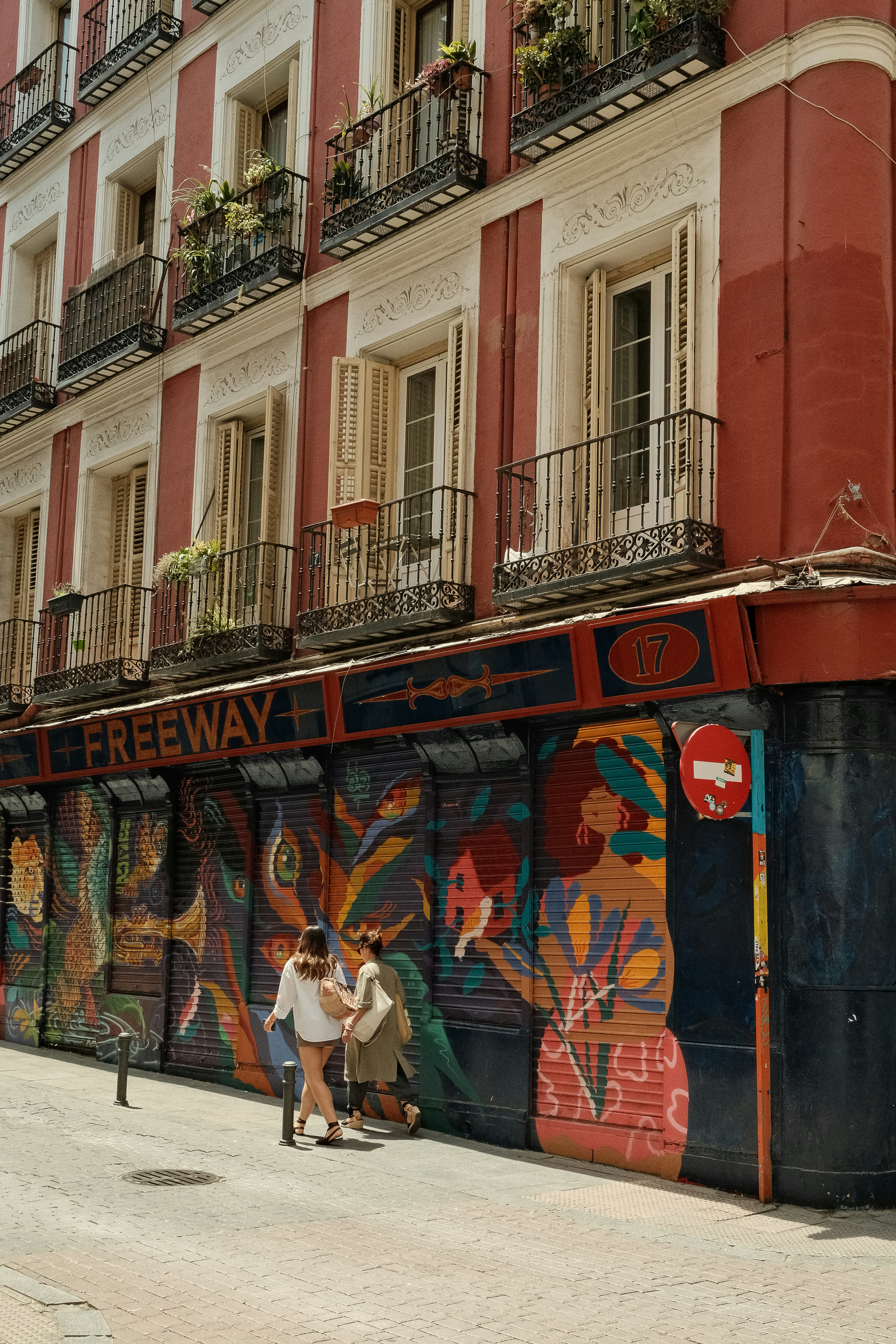 Trio by the Graffiti Façade: Sunlit Street Portrait