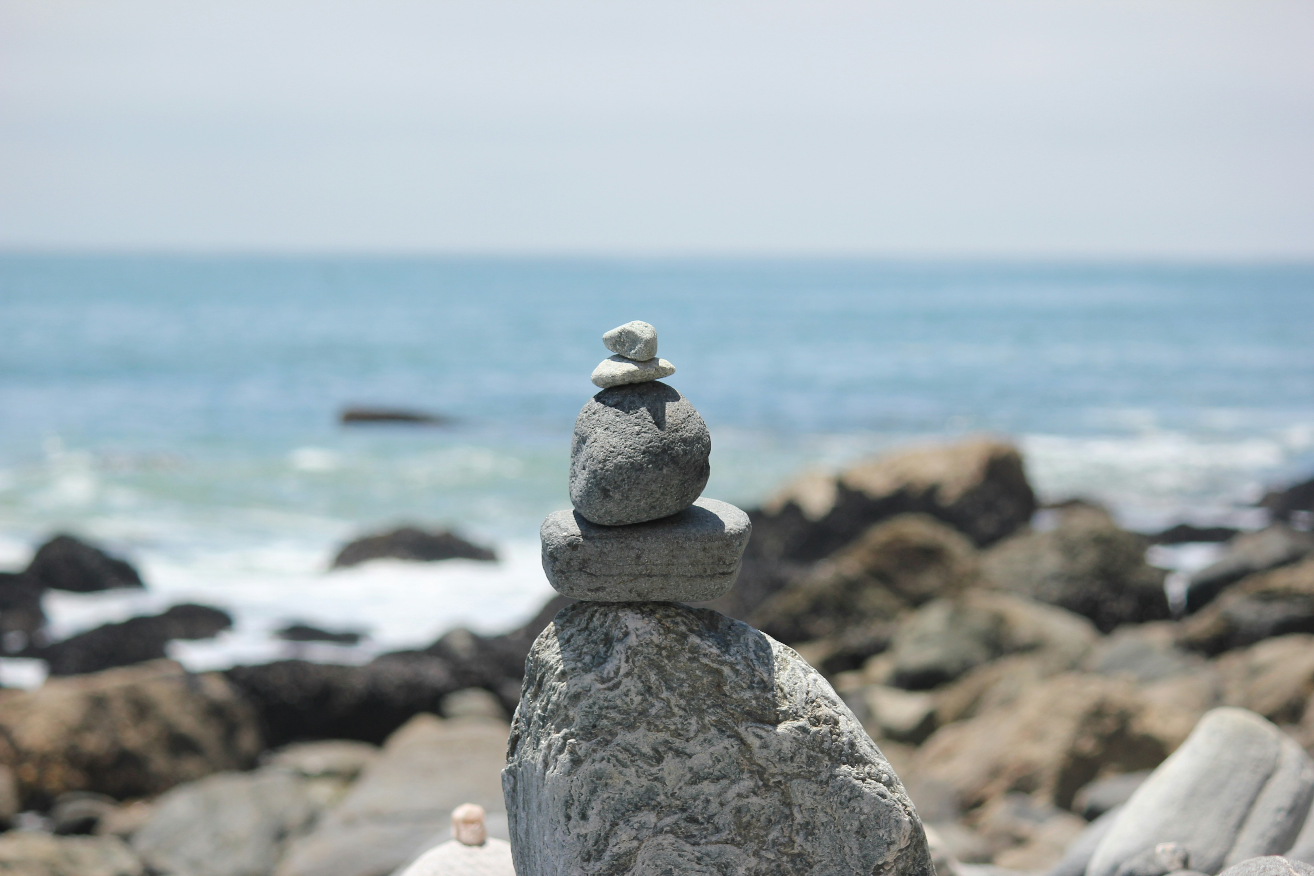 Zen Stack by the Tide: Pebble Beacon on a Sunlit Beach