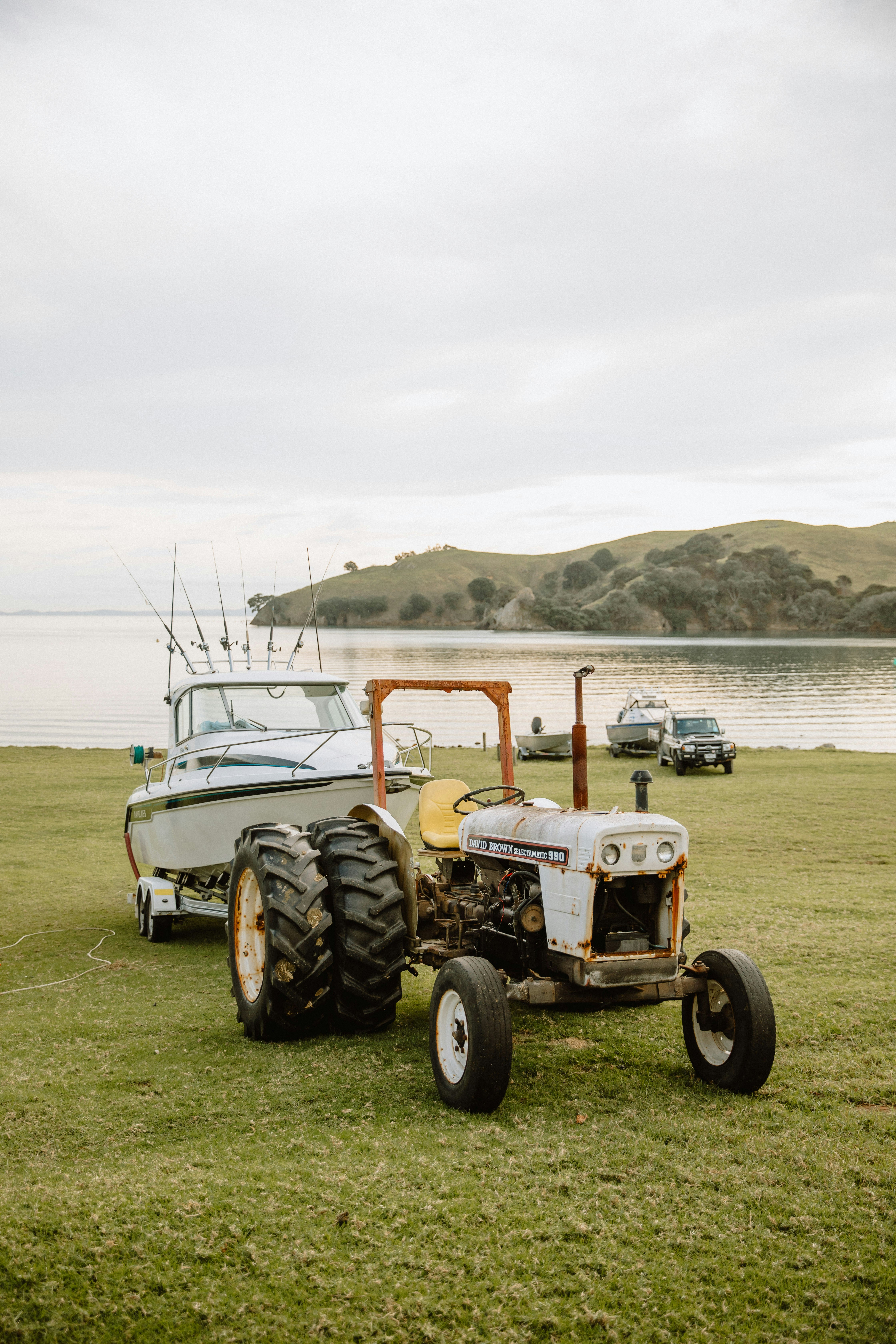 Rusty Tractor in a Tranquil Lakeside Meadow