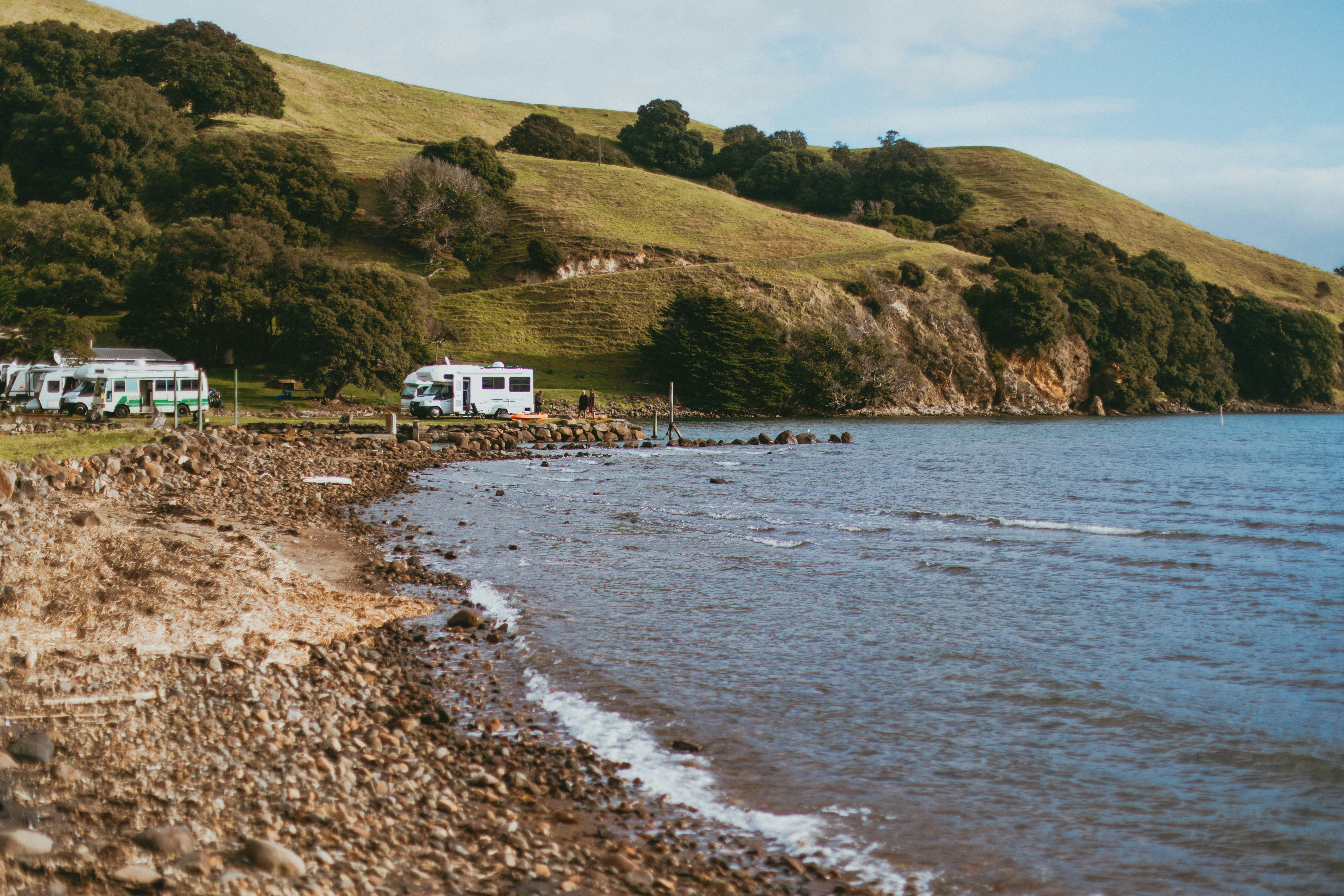 Caravans by the Pebble Shore: Quiet Camp Along Rolling Coastal Hills