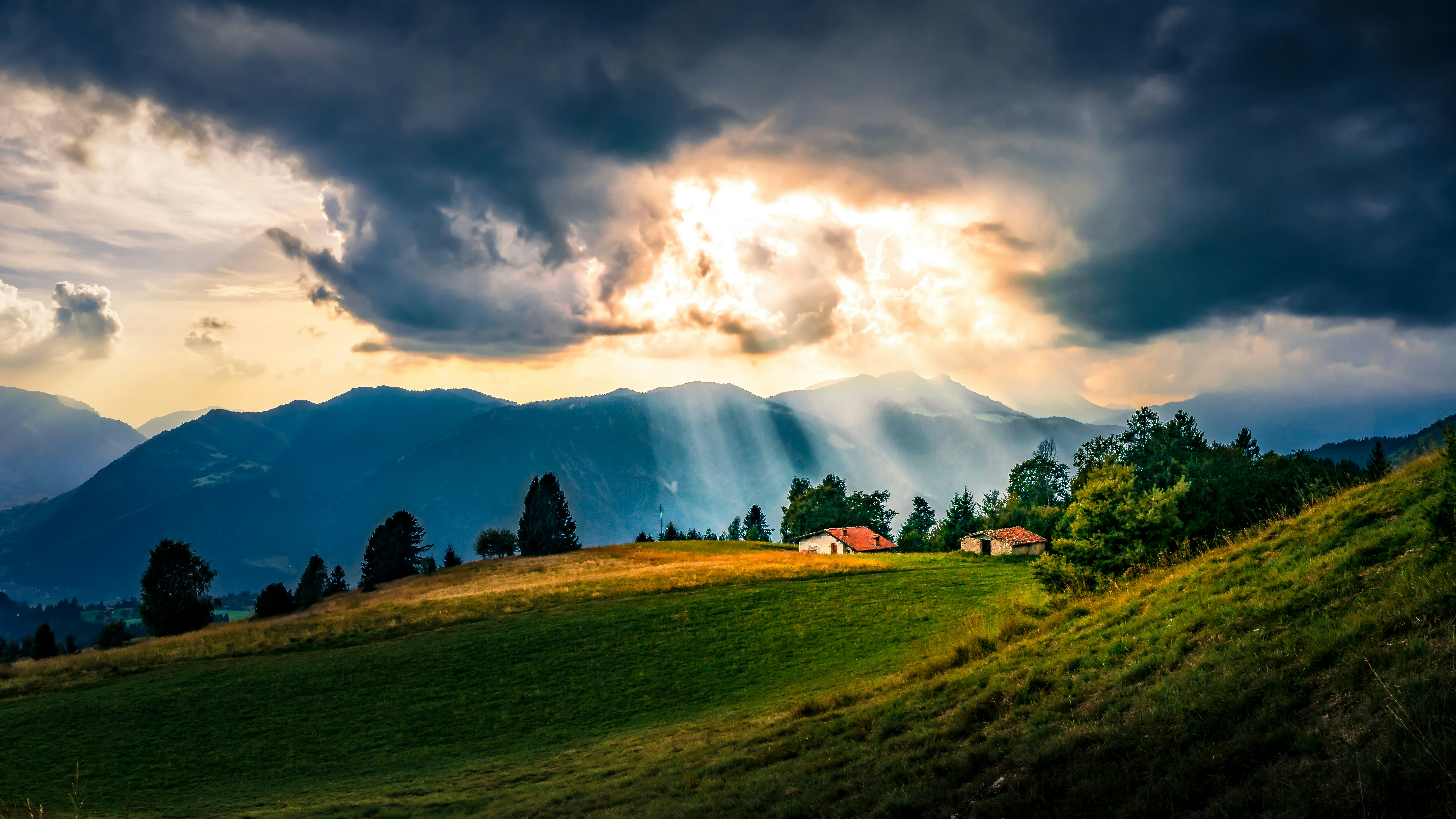 Ridge of Light: Sunbeams, Cottages, and Distant Peaks