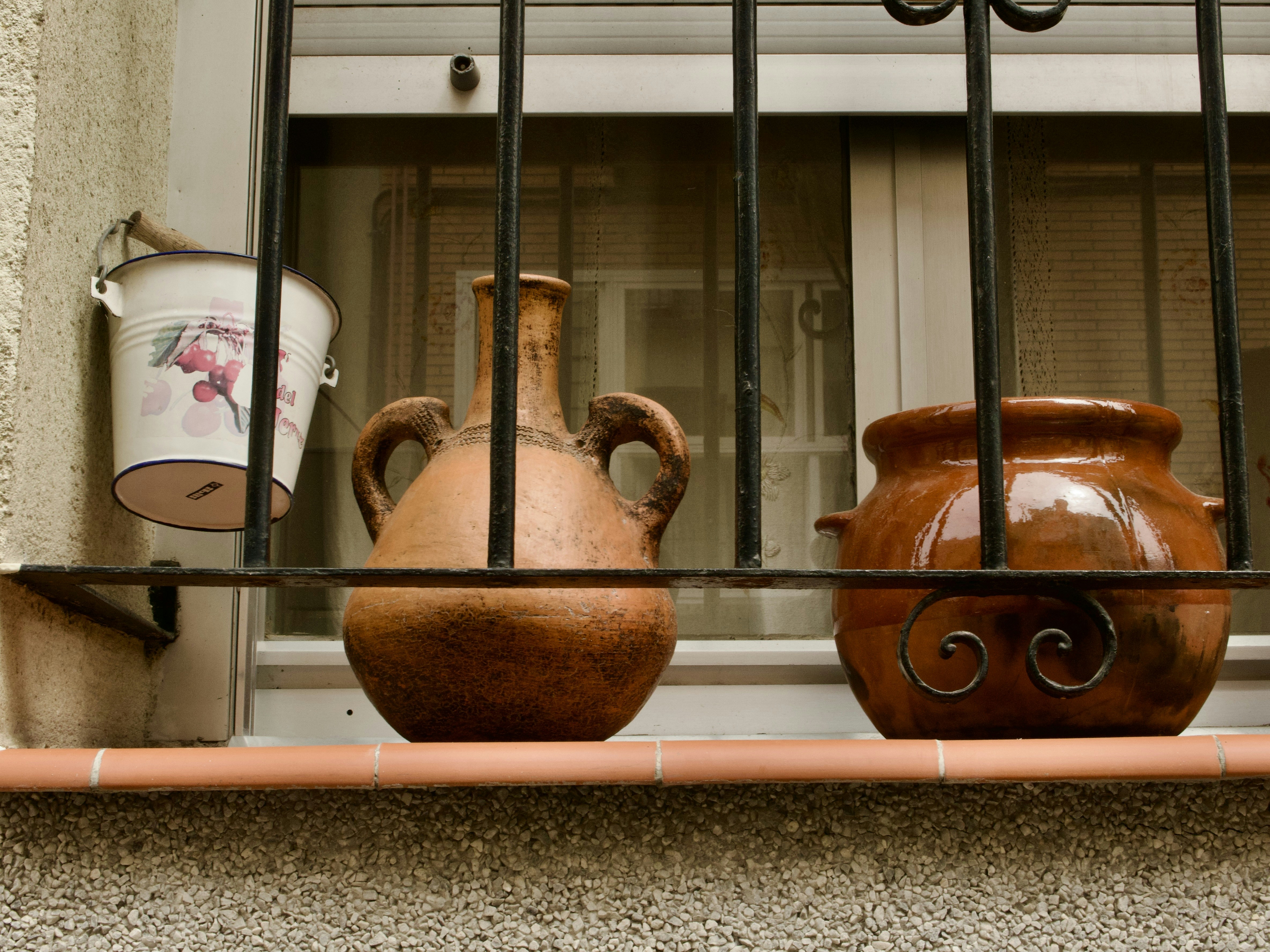 Terracotta Echoes: Two Ceramic Vessels Guarding a Windowsill
