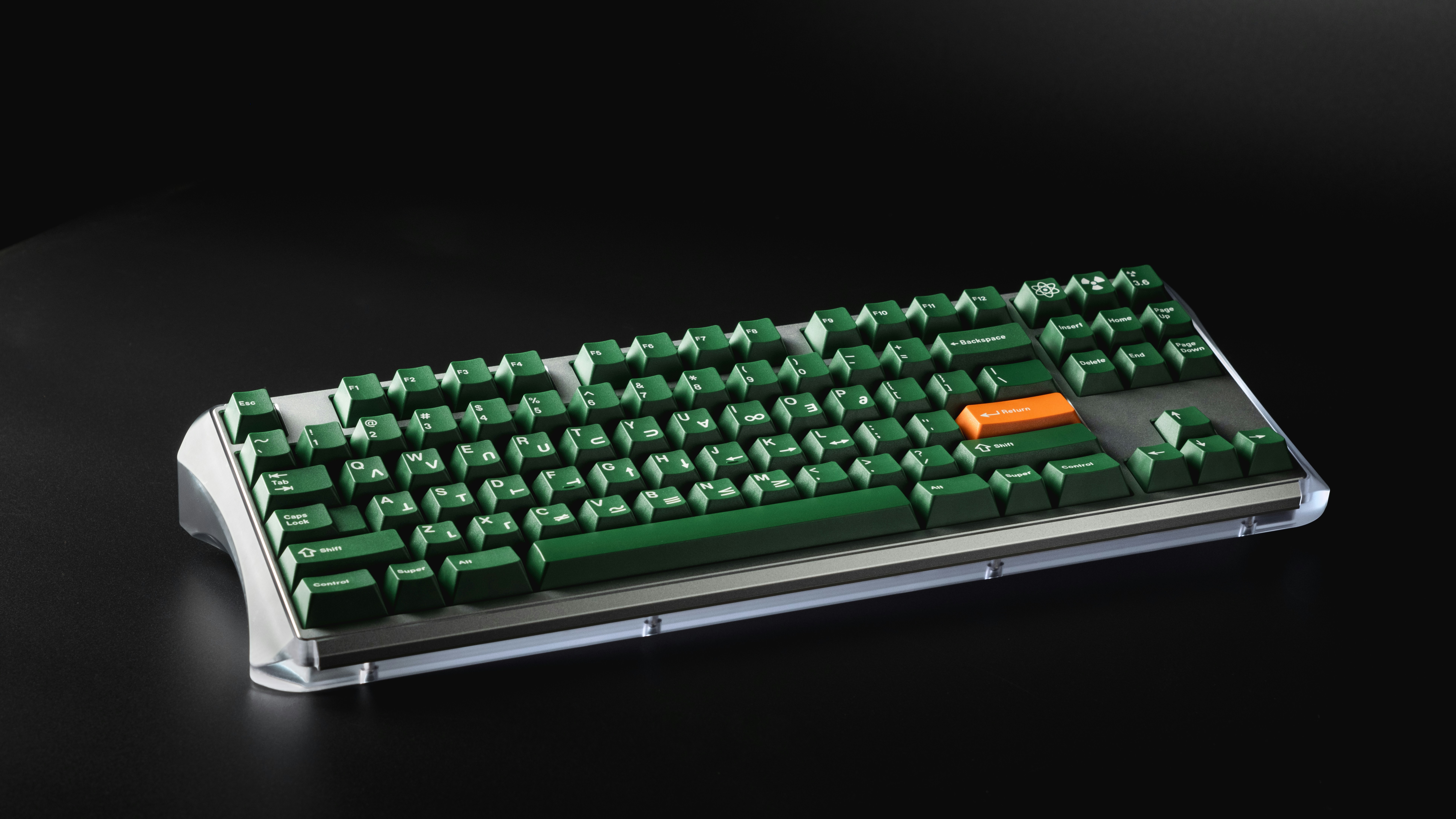 A green computer keyboard sitting on top of a table photo – Free Setup ...